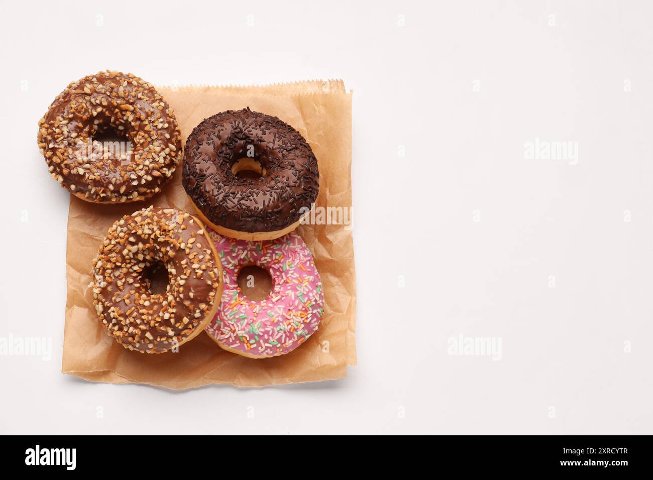 Paper bag with sweet donuts on white background Stock Photo - Alamy