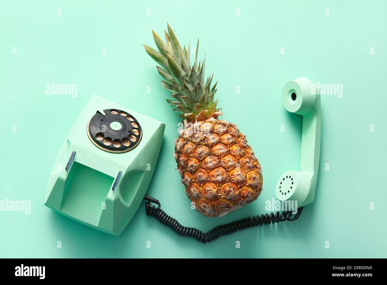 Fresh pineapple and telephone on turquoise background Stock Photo - Alamy