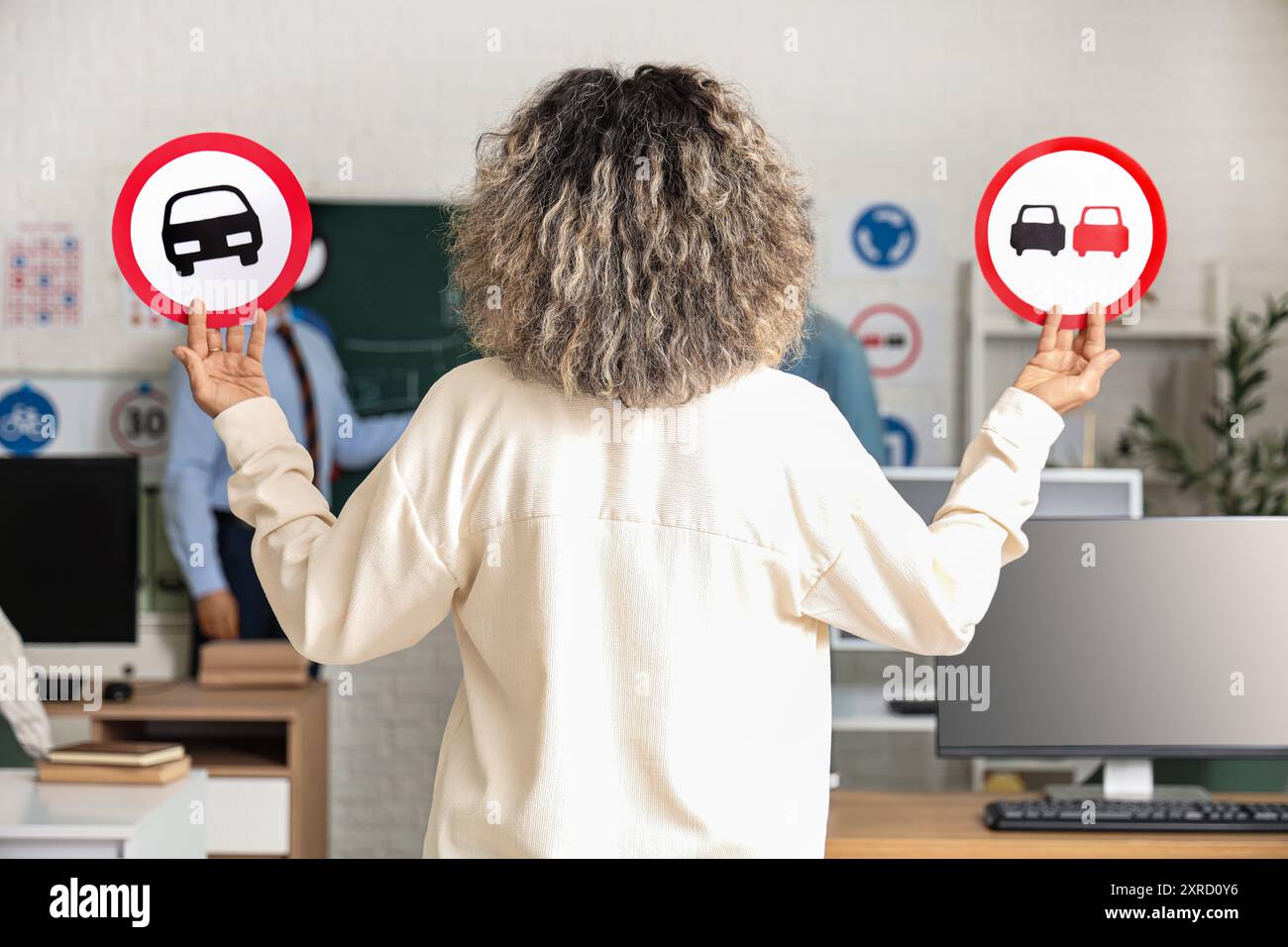 Mature woman with road signs at driving school, back view Stock Photo ...