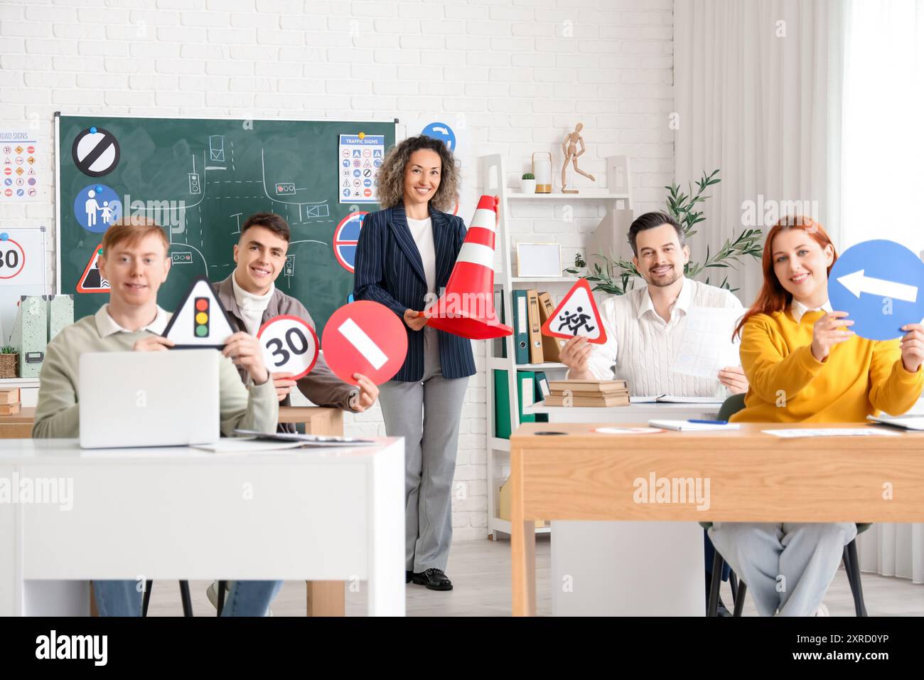 People with traffic signs and instructor at driving school Stock Photo ...