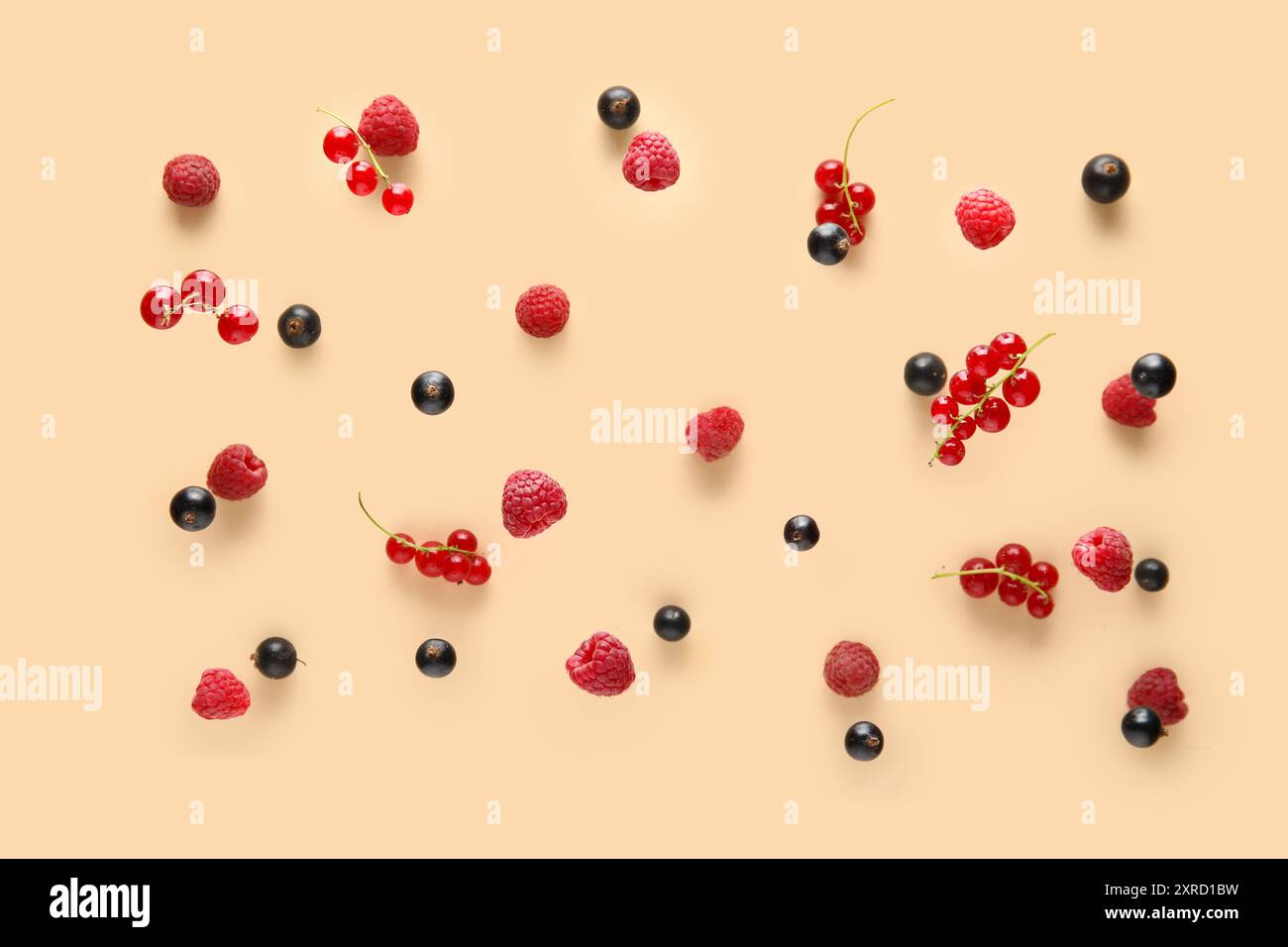 Different berries flying on beige background Stock Photo - Alamy