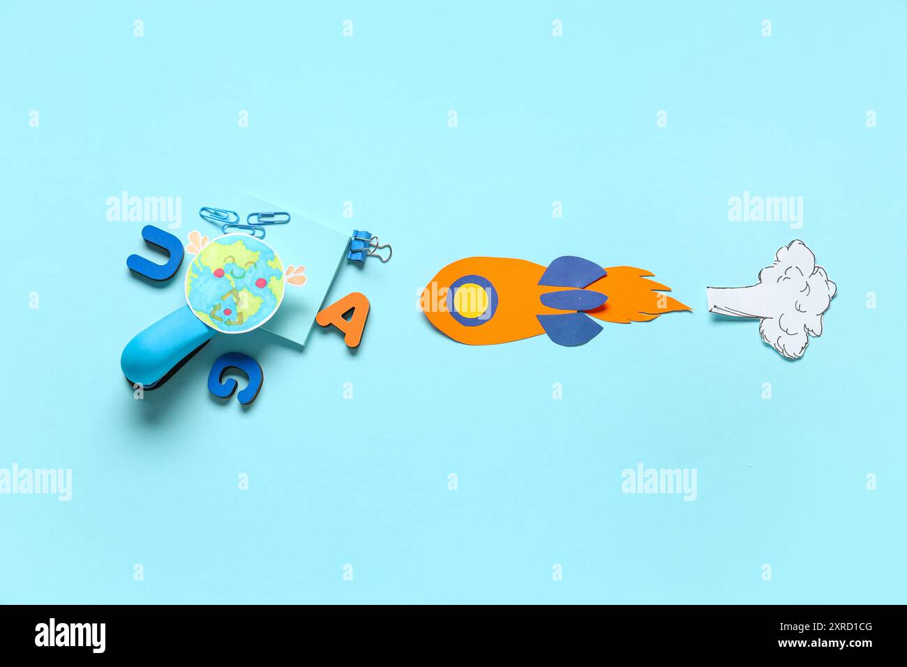 Paper rocket, paper planet Earth and school stationery on blue ...