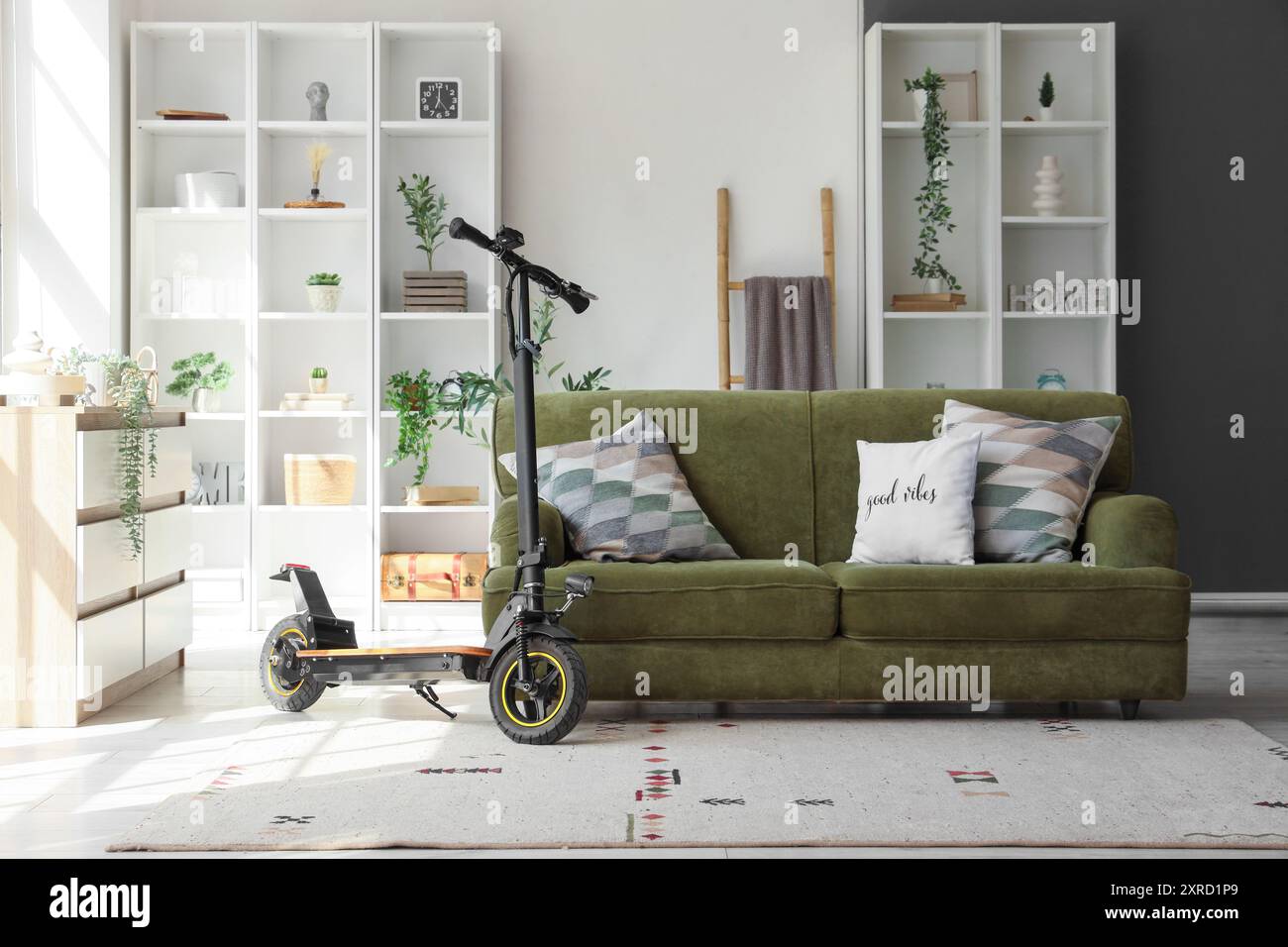 Interior of living room with electric scooter, sofa and shelf units ...