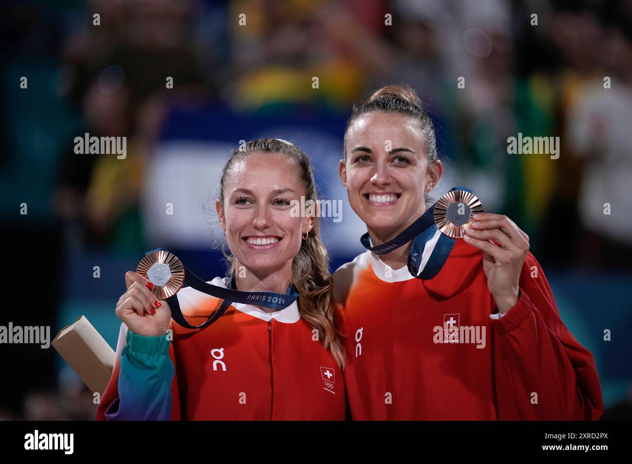 Switzerland's Nina Brunner, left, and Tanja Hueberli hold up their ...