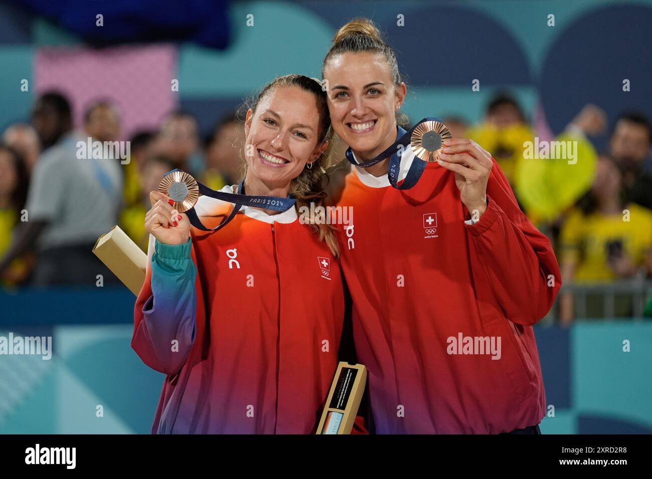 Switzerland's Nina Brunner, left, and Tanja Hueberli hold up their ...