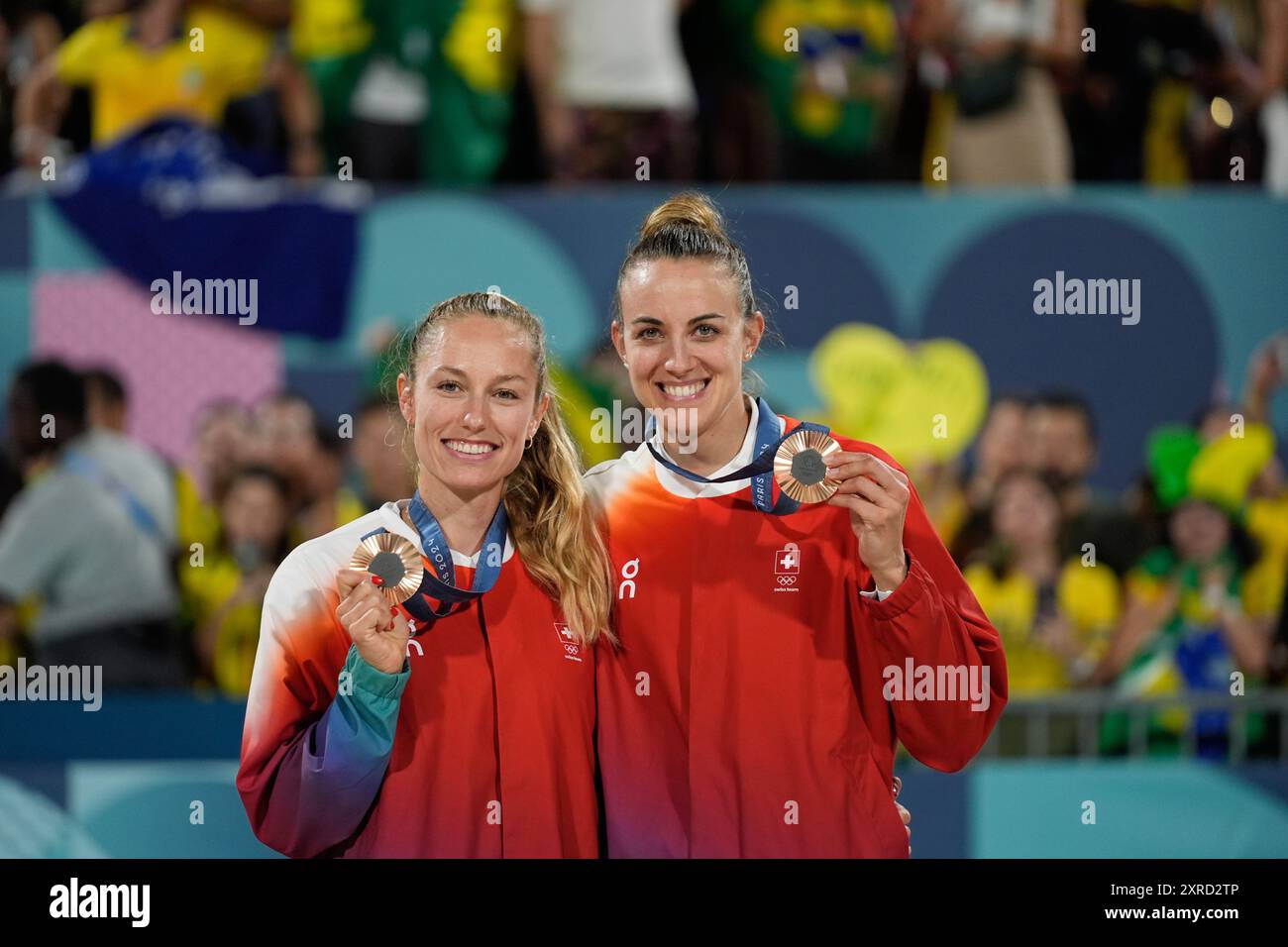 Switzerland's Nina Brunner, left, and Tanja Hueberli hold up their ...