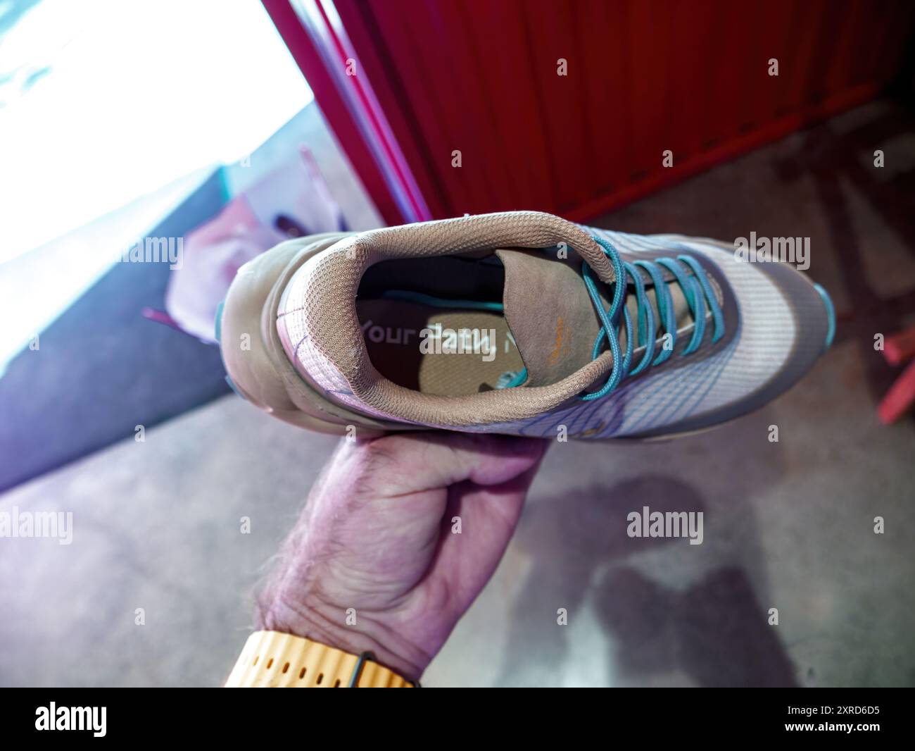 Inca, Spain - Jul 5, 2024: A male hand inspects the interior sole of a ...