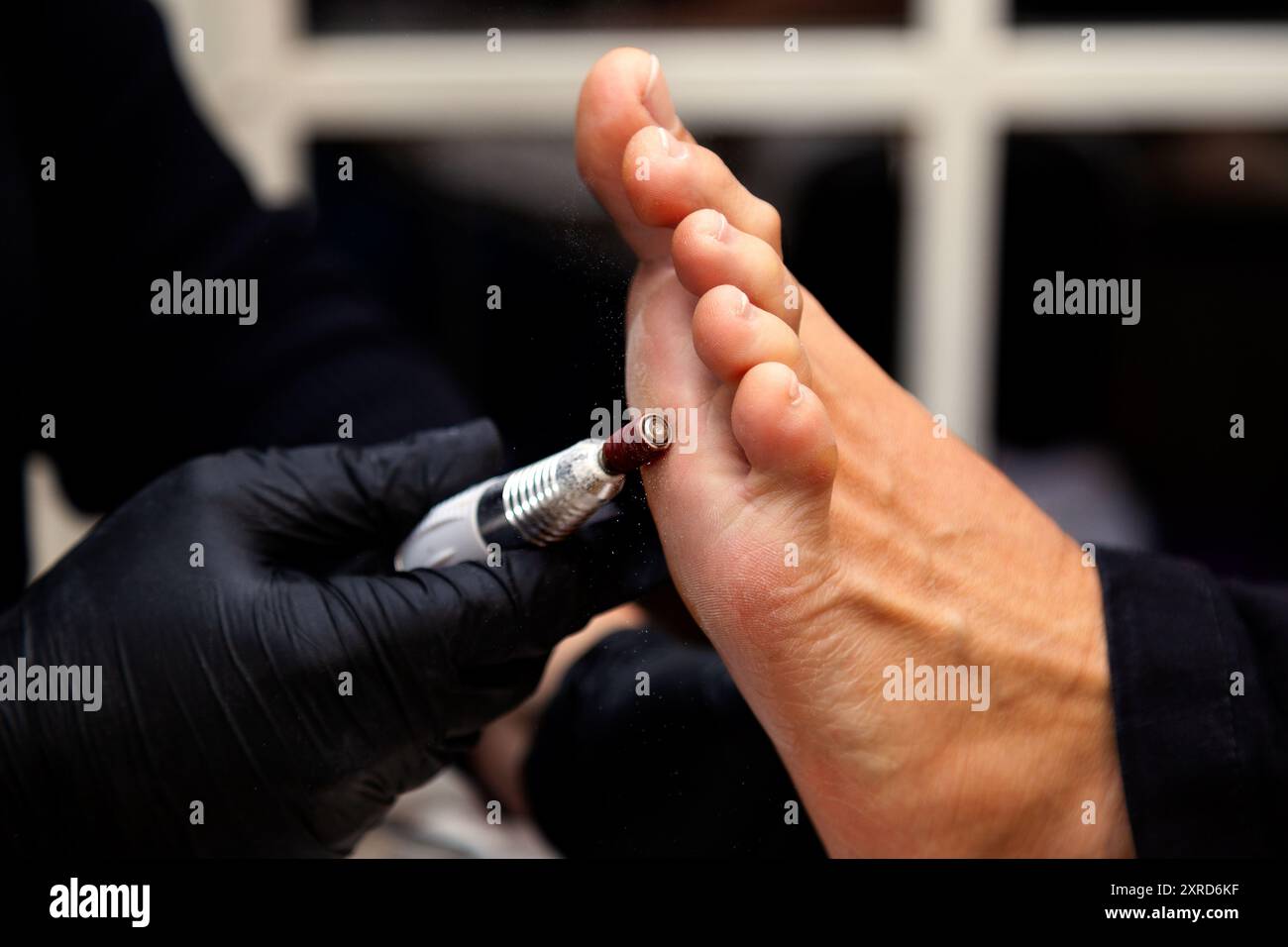 Skin filing of the lateral sole foot area. Pedicure session at beauty ...