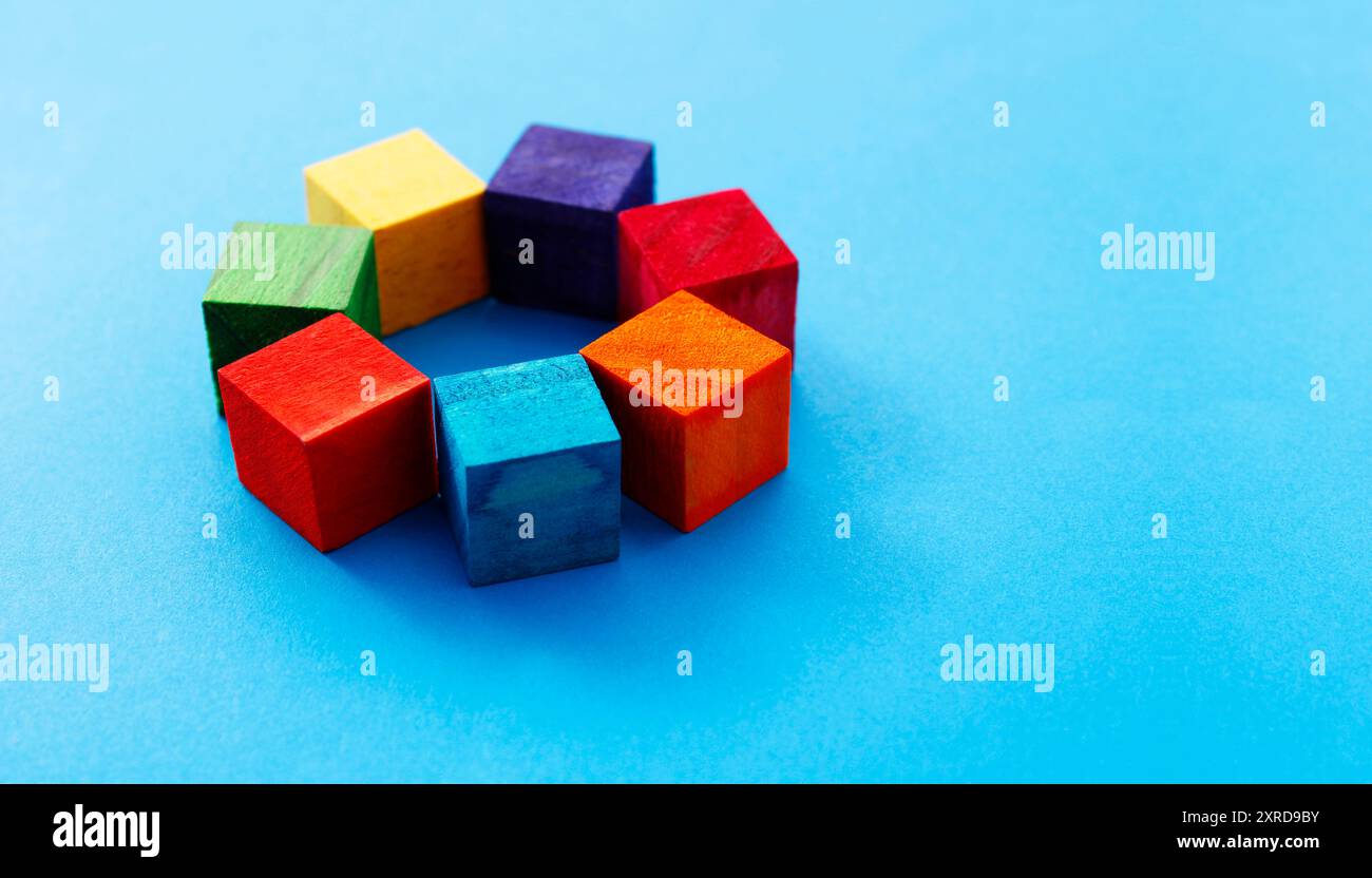 Colorful wooden cubes grouped together in a circle Stock Photo - Alamy