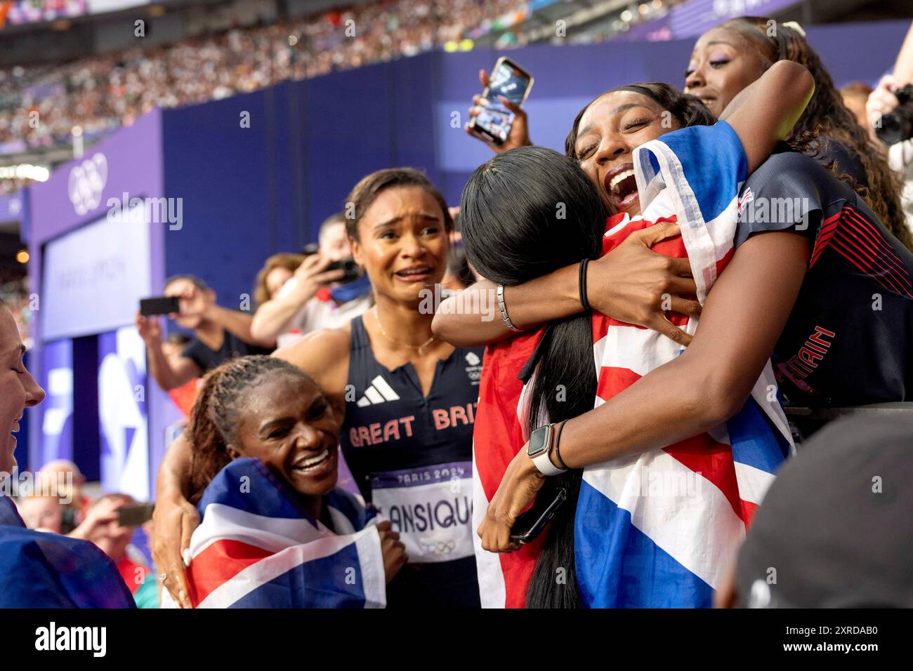 Britain's Bianca Williams, right, hugs Daryll Neita as Imani Lansquiot ...