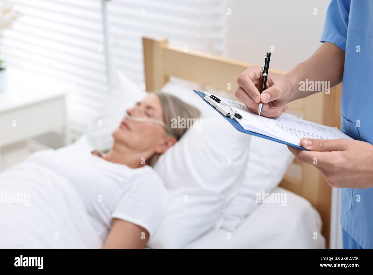 Coma patient. Doctor near unconscious mature woman in hospital, closeup ...