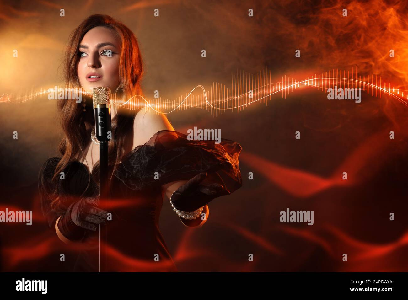 Beautiful woman with microphone singing in color lights. Audio ...