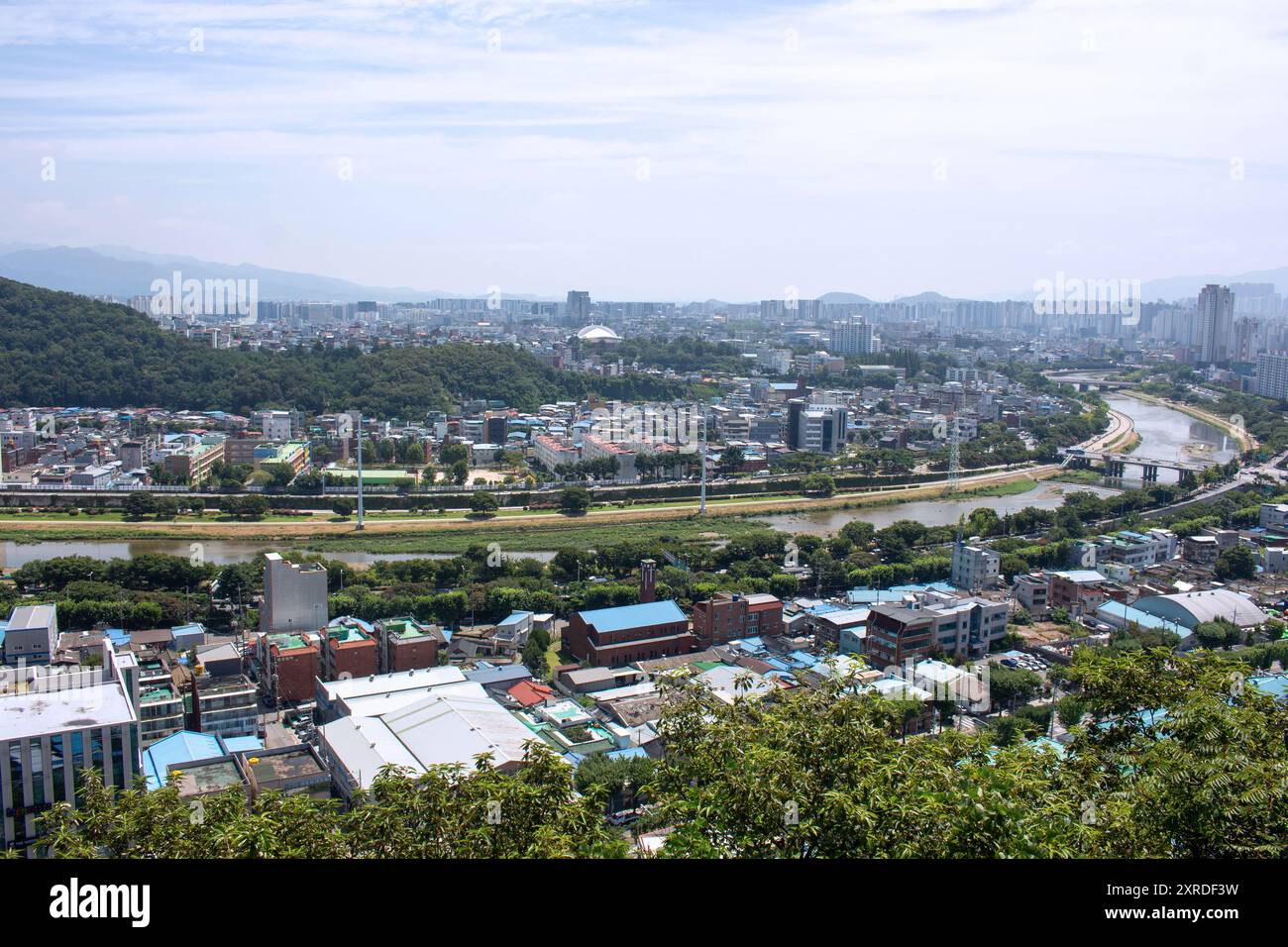 A vibrant cityscape where urban development meets nature, with a ...