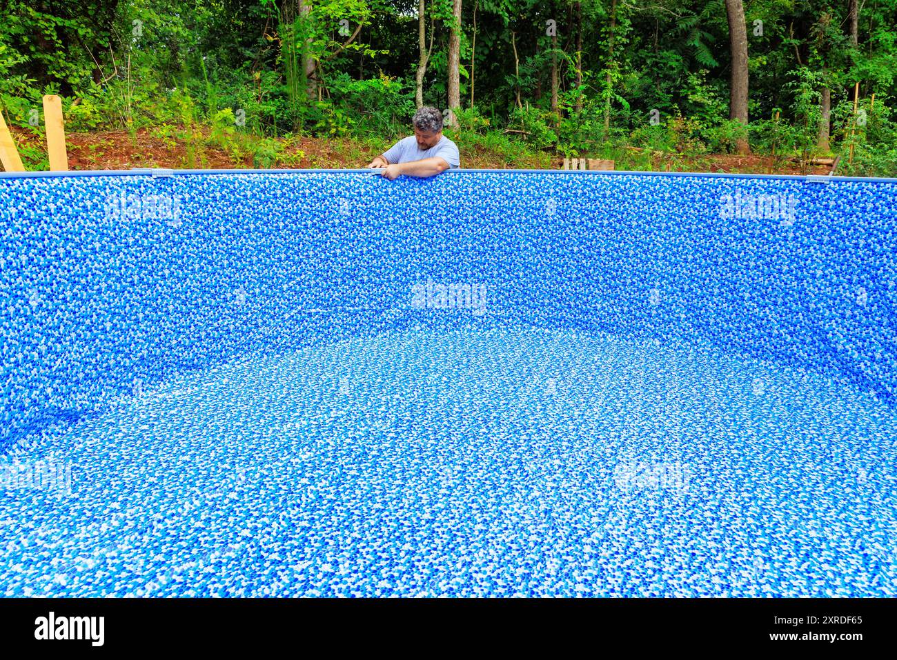 Ground swimming pool assembly at back of house on construction ground ...
