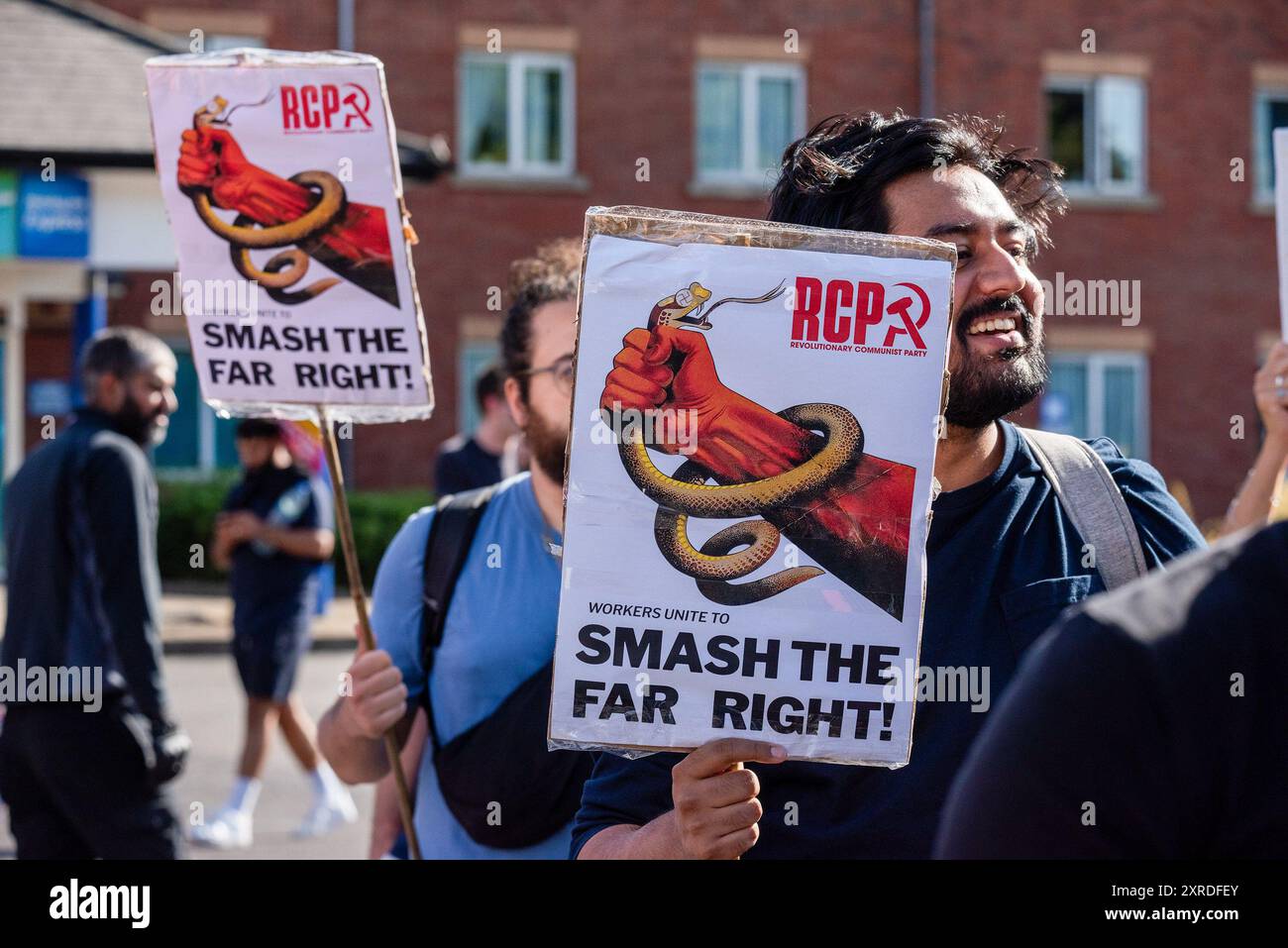 Crawley, UK. 09th Aug, 2024. Protesters hold placards during the ...