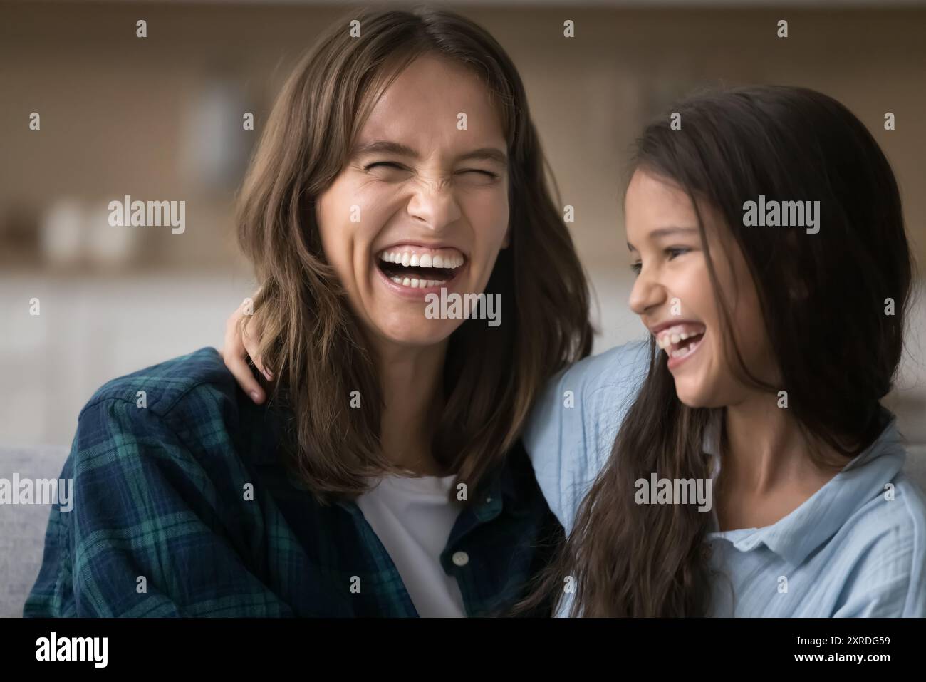 Cheerful excited mother and daughter child laughing out loud ...