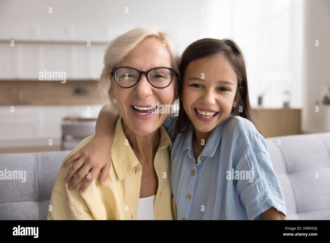 Positive grandmother in glasses and cute grandkid girl hugging Stock ...