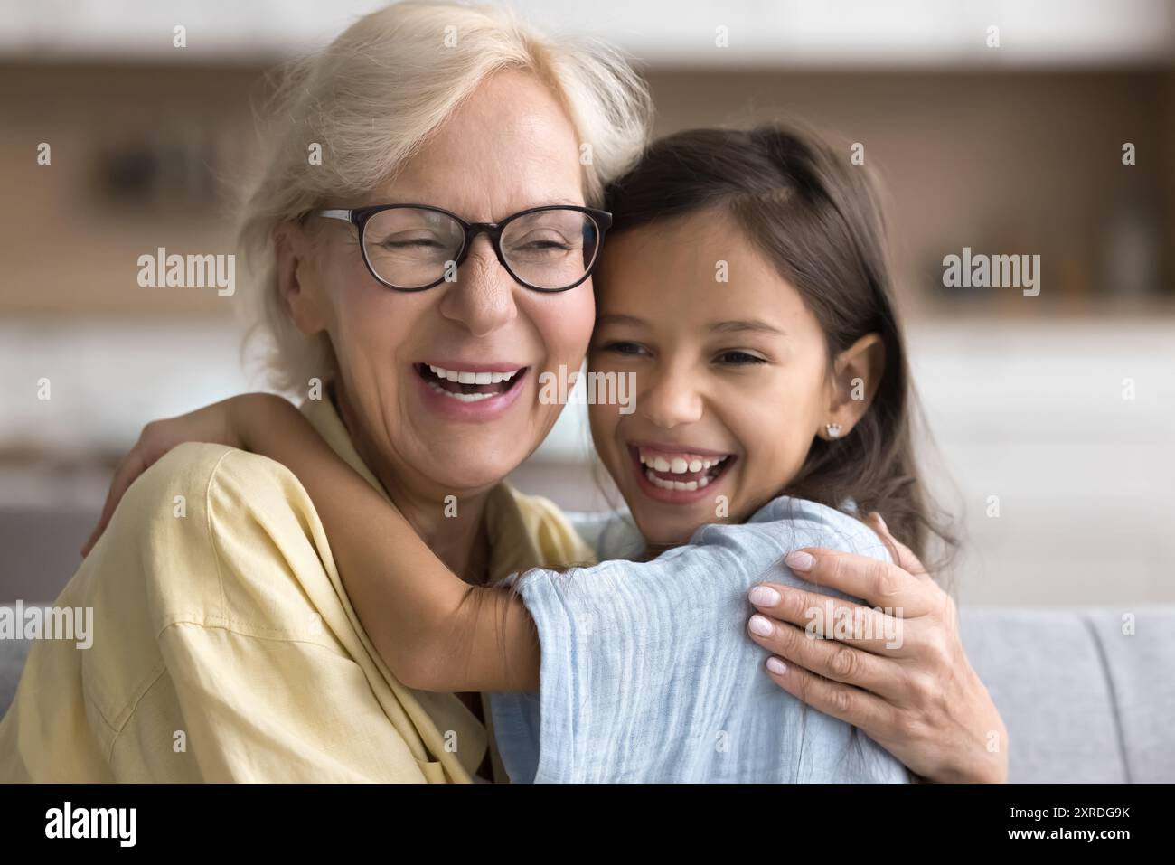 Joyful granddaughter and granny hugging with faces touch Stock Photo ...