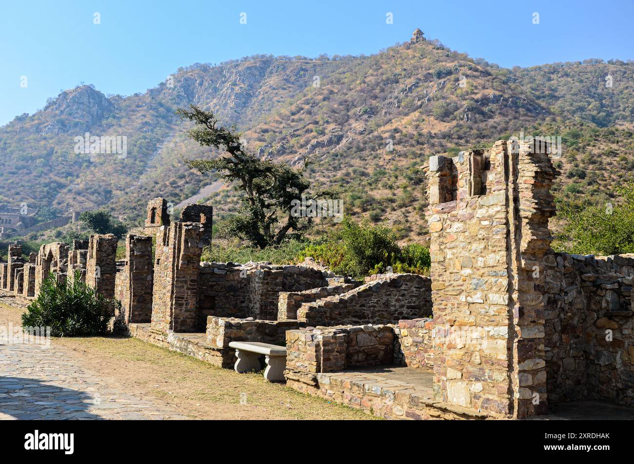Stone wall with arches in the ruins of 16th century Bhangarh fort at ...