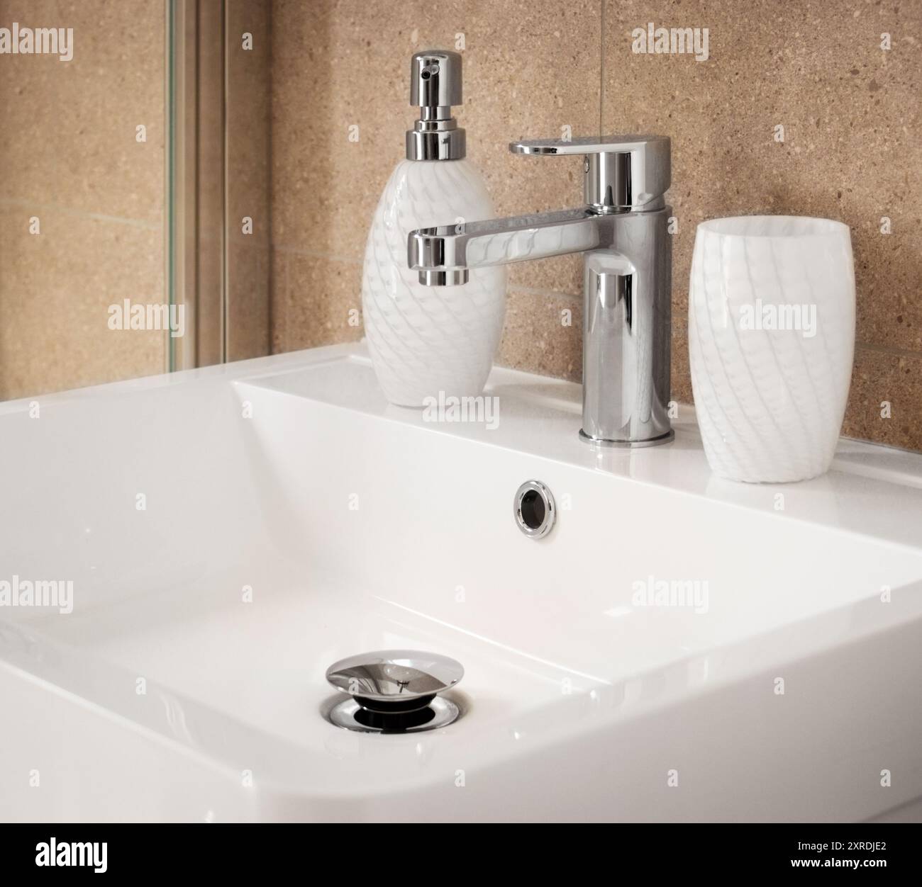 Empty white vanity counter with ceramic washbasin. Modern style faucet ...