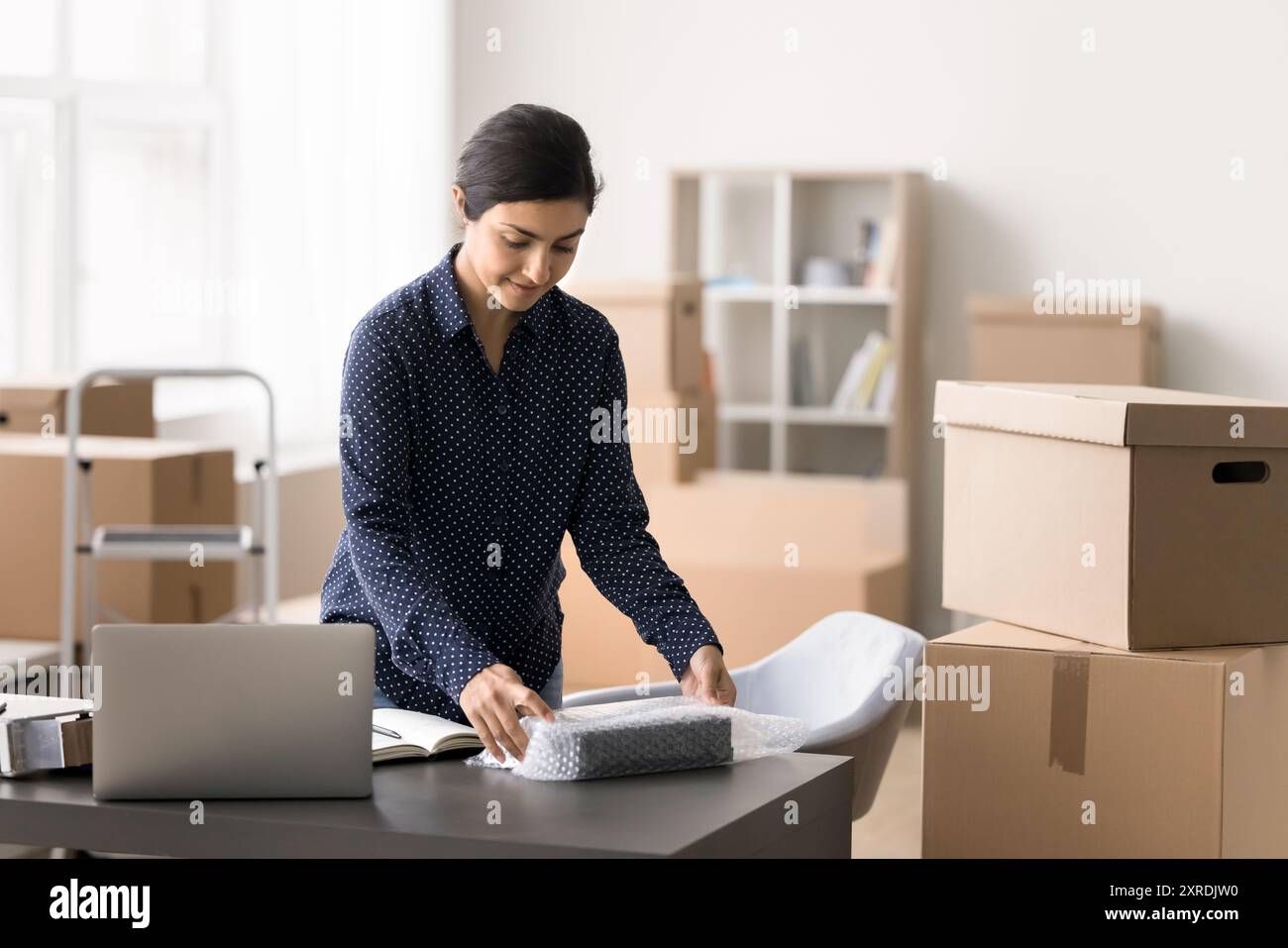Indian woman packing bought goods working in warehouse Stock Photo - Alamy