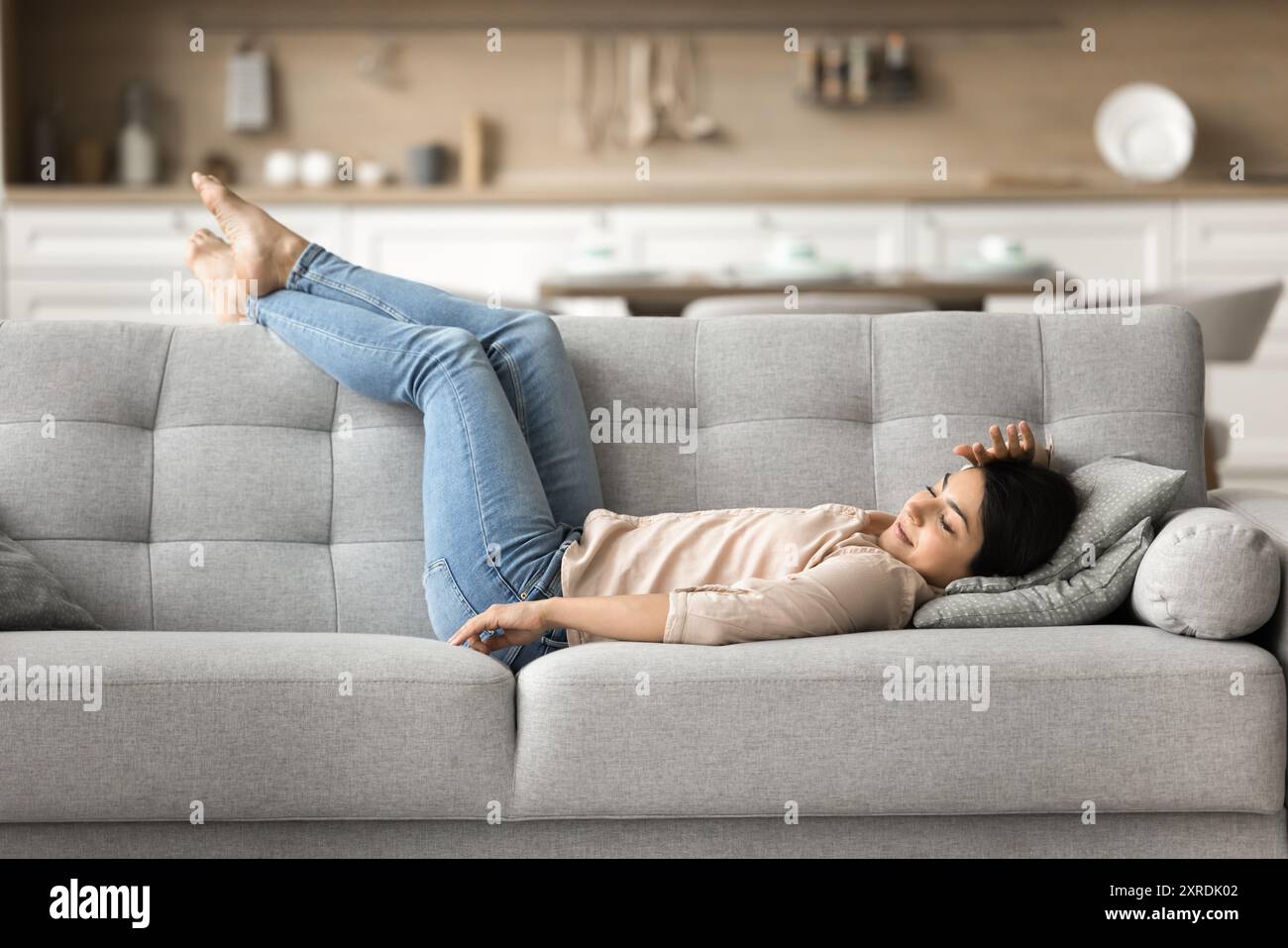 Serene Indian woman enjoy daytime nap lying on comfy sofa Stock Photo ...