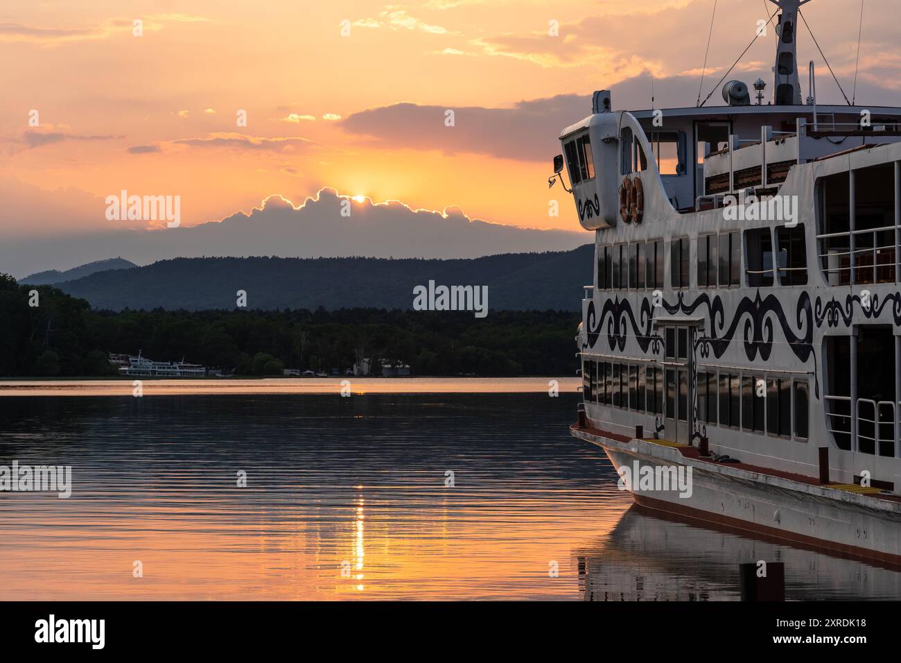 Lake Akan, Japan: Dramatic sunset over a cruise ship on the lake Akan ...