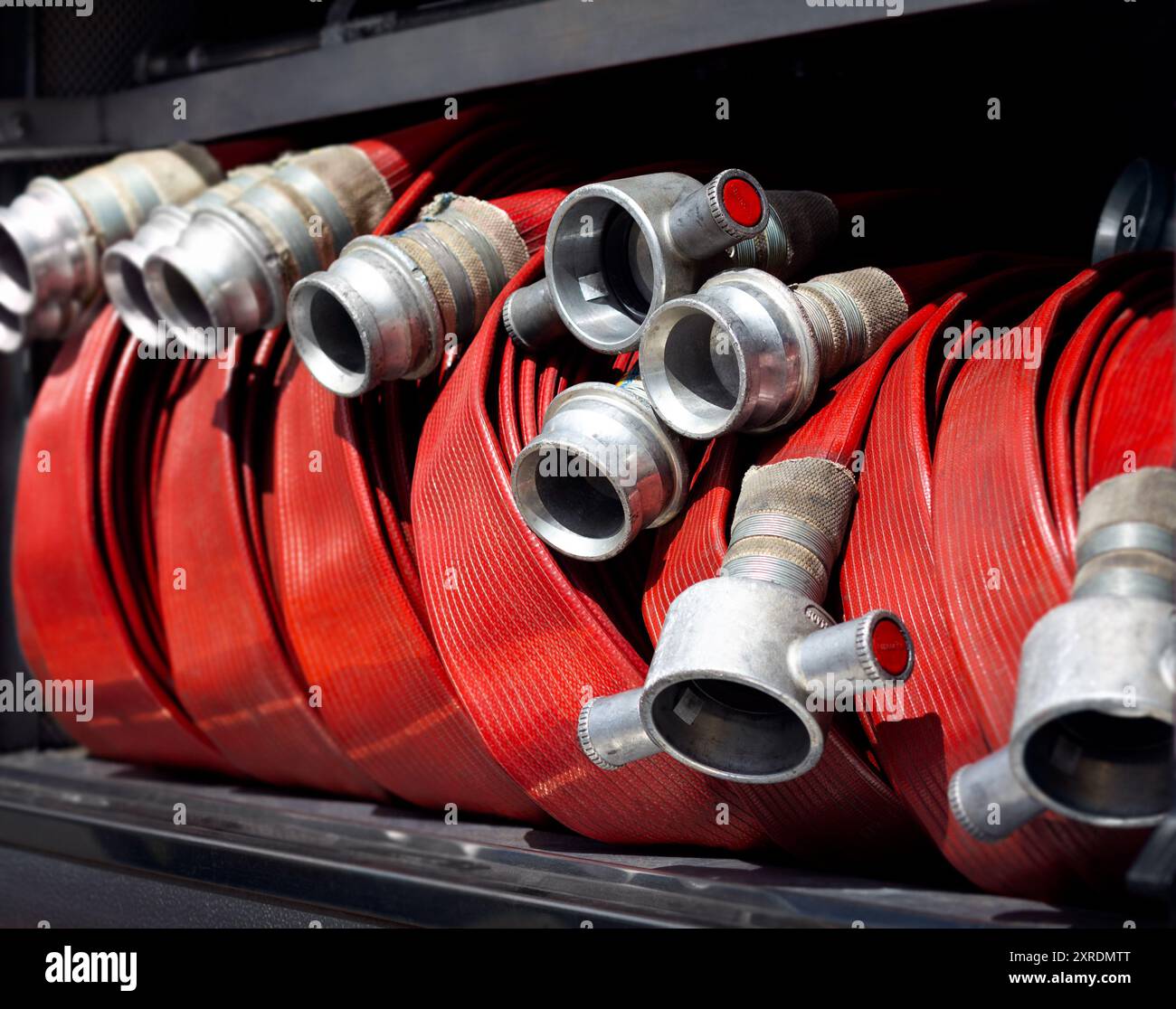 Coiled fire hoses as typically seen on a fire truck appliance. Fire ...