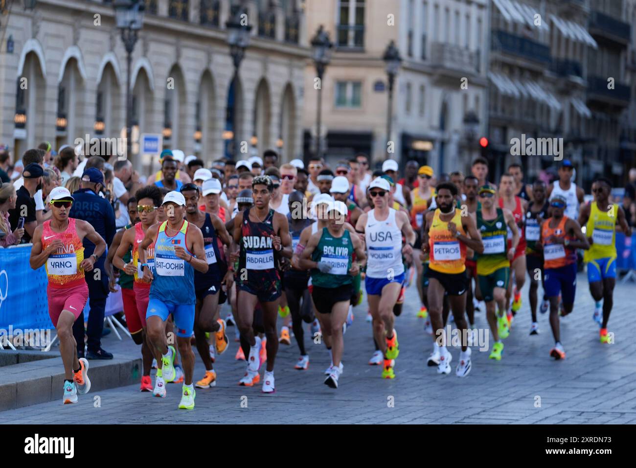 Competitors run through the streets of central Paris during the men's ...