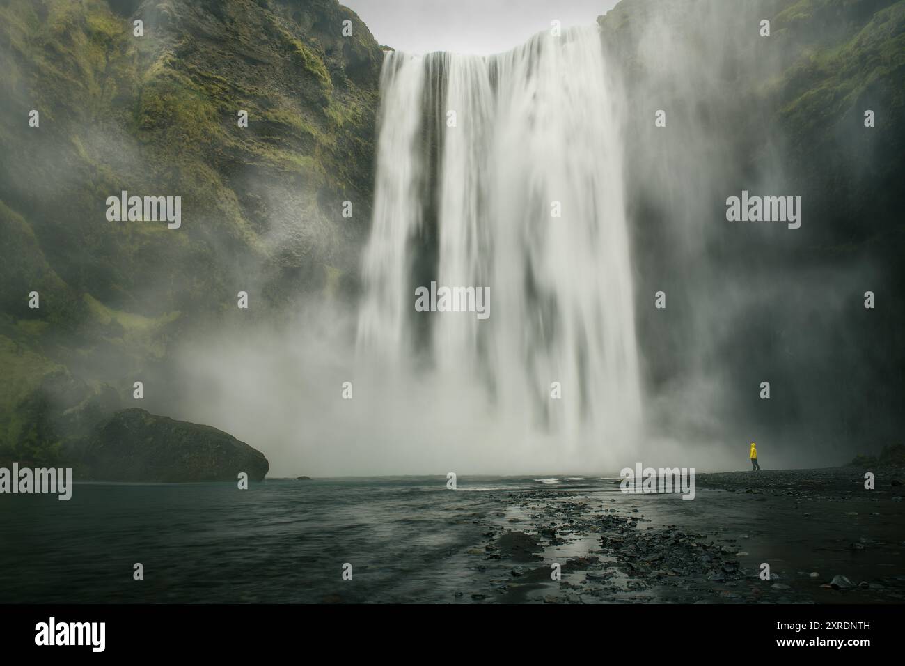 Lone person human hiker tourist at Skogafoss waterfall in Iceland ...