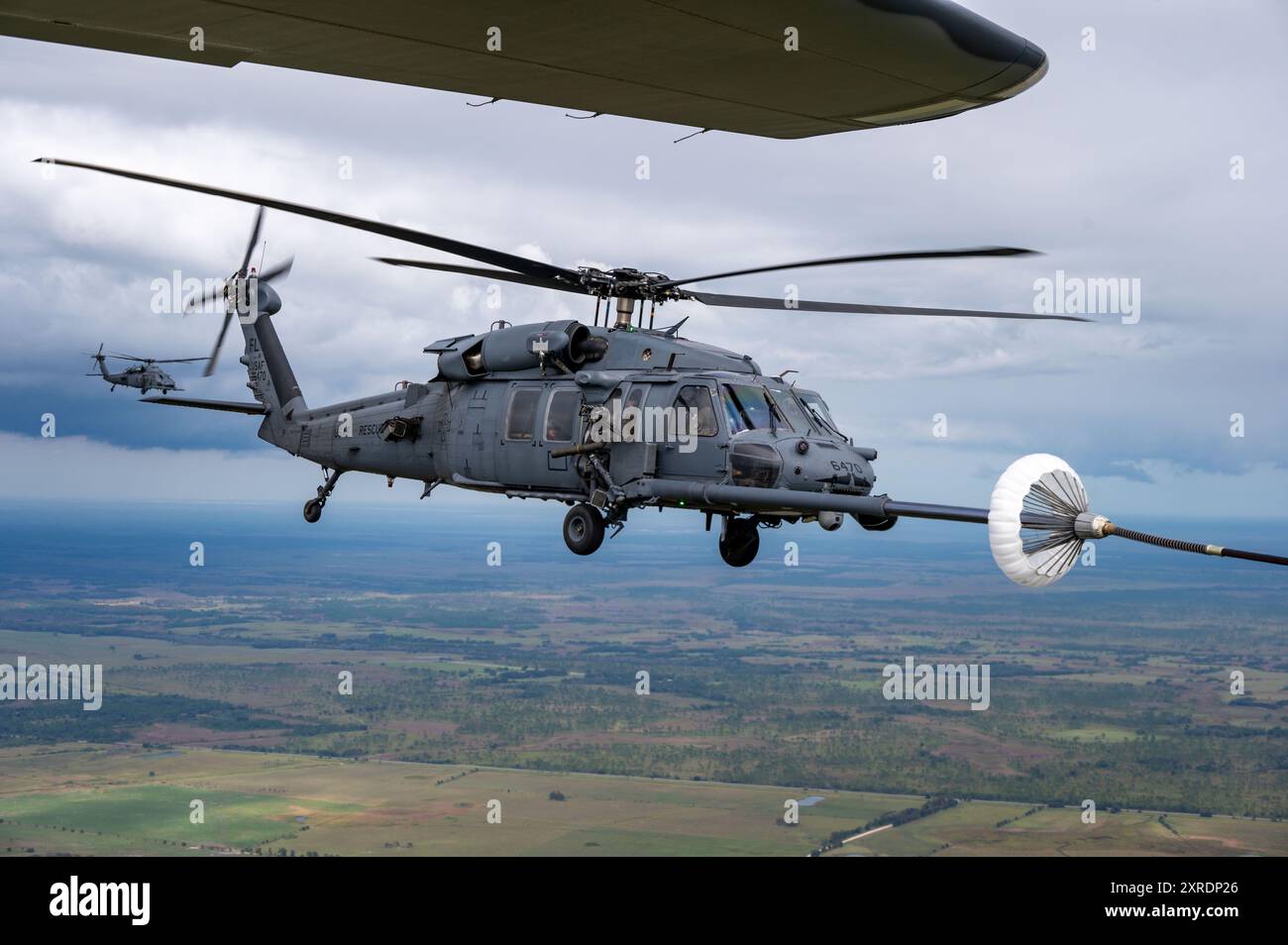 An HH-60G Pave Hawk helicopter receives fuel from an HC-130J Combat ...