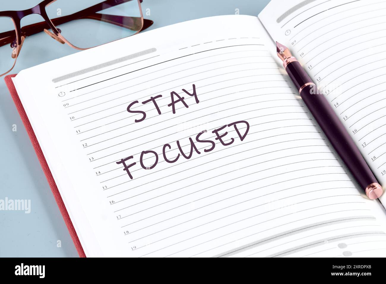 STAY FOCUSED text in the notebook of a businessman, manager Stock Photo ...