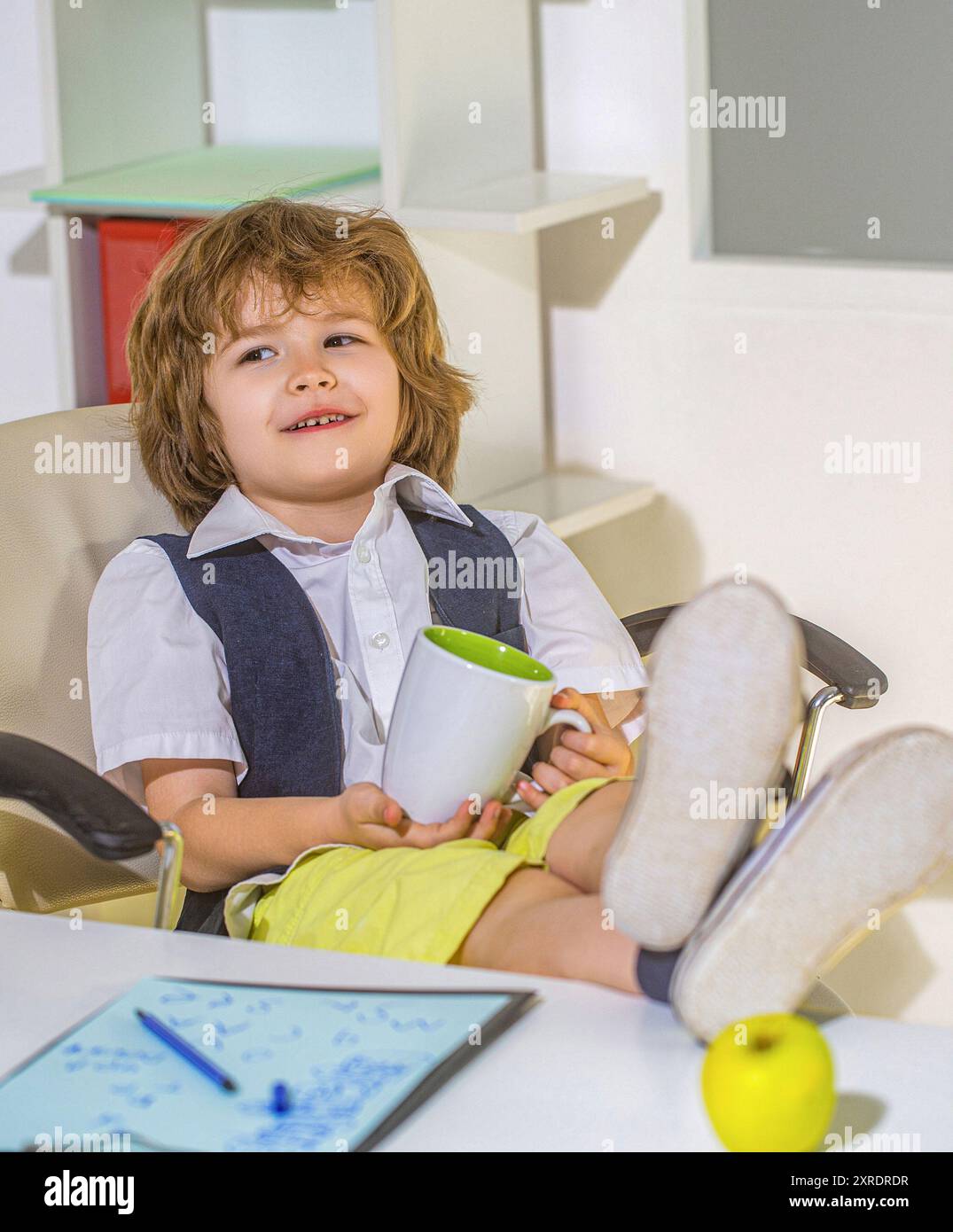 Smiling little boss in the office. Little kid boy businessman making ...