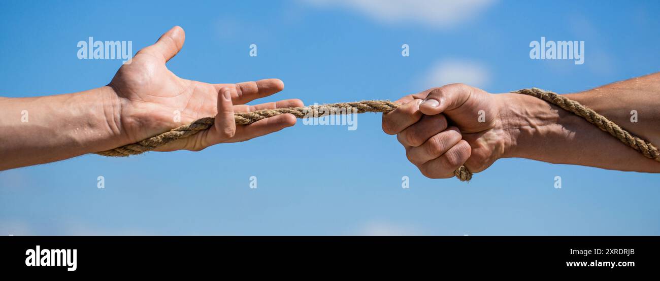 Hand holding a rope, climbing rope, strength and determination. Strong hold. Two hands, helping ...