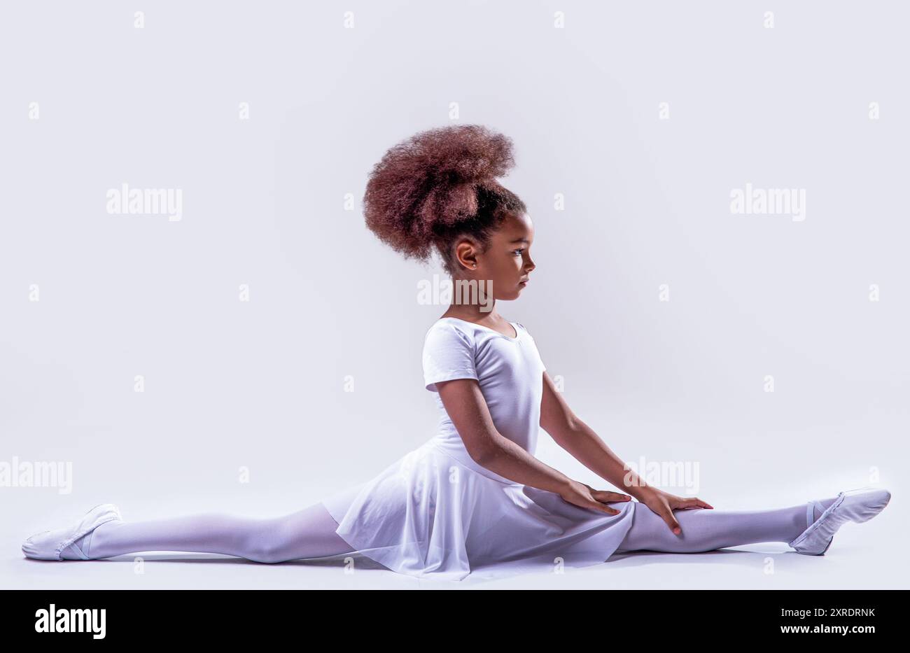 Ballerina in a white leotard. Little ballerina girl laying on the ...