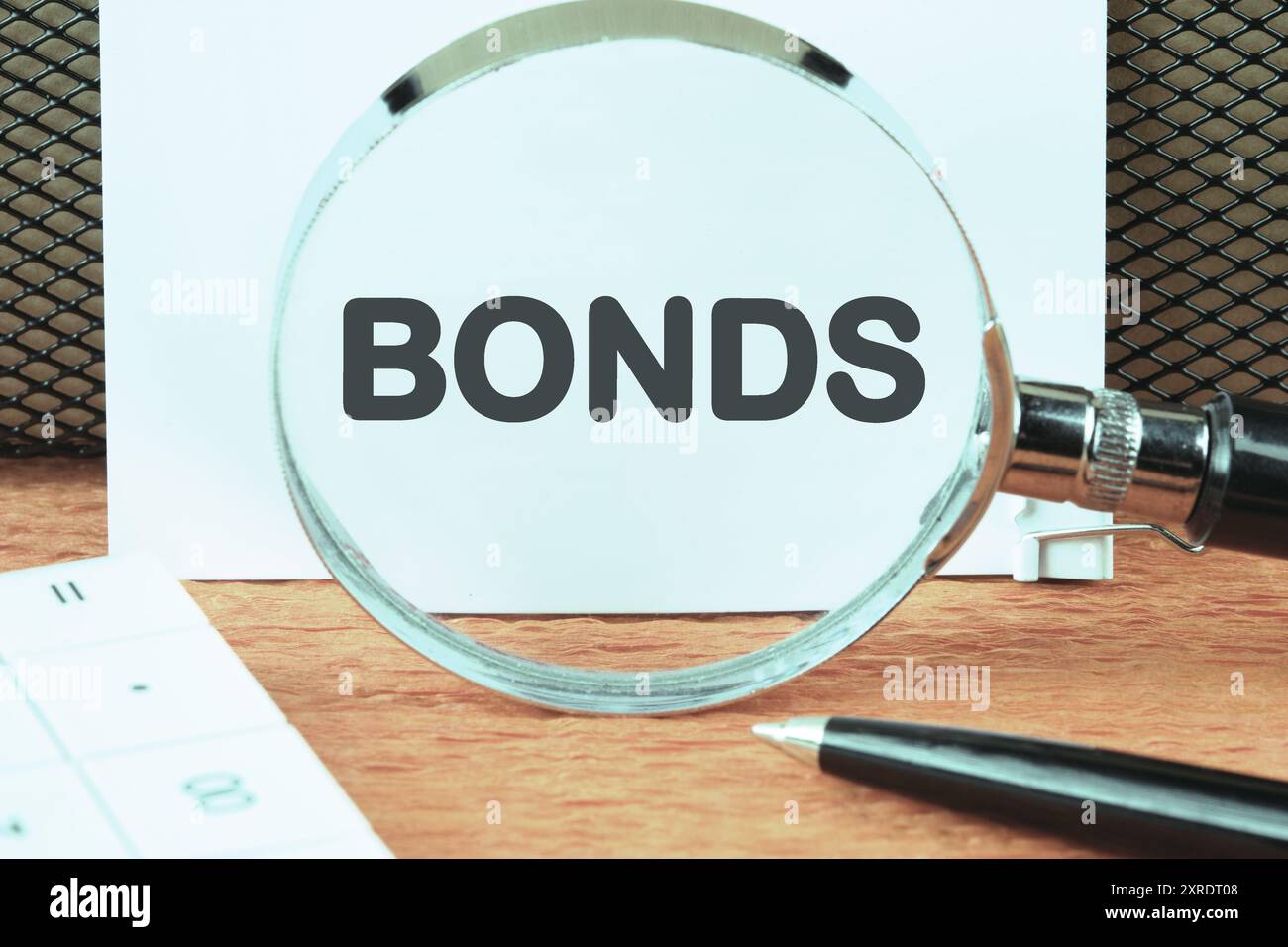 BONDS word through a magnifying glass on a clean white sheet Stock ...