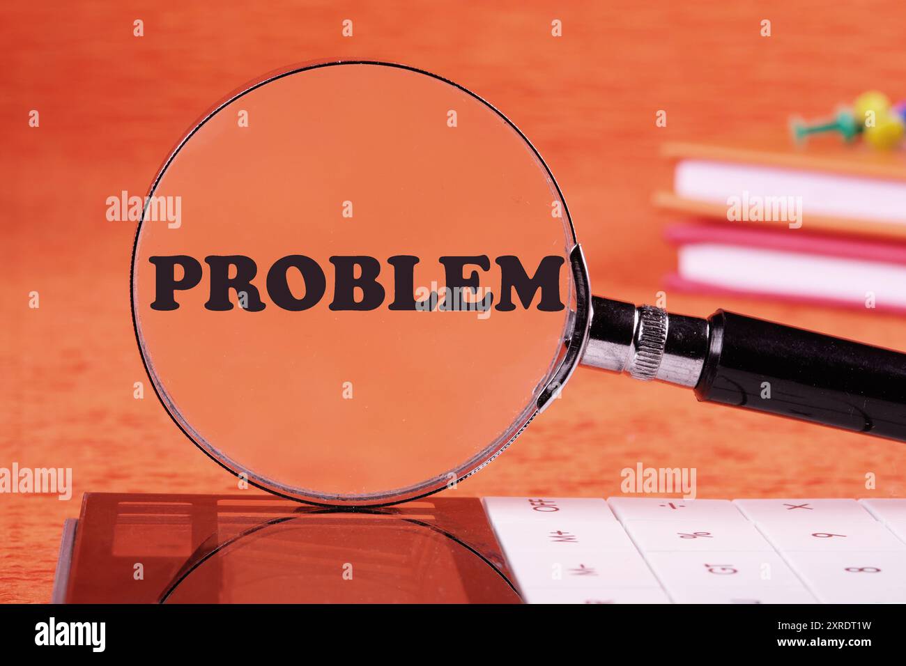 PROBLEM word written through a magnifying glass on an orange background ...
