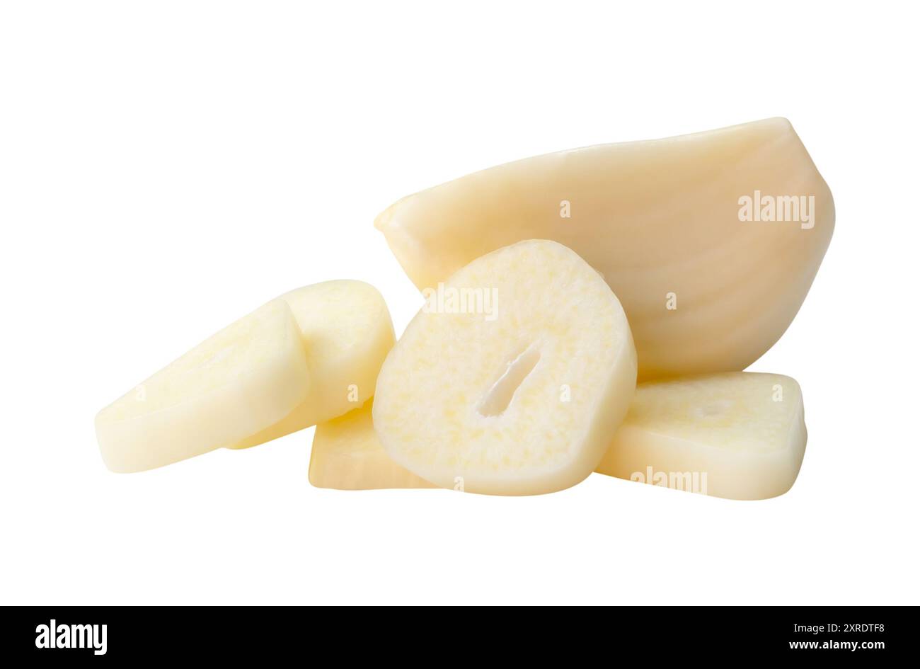 Side view of peeled white garlic cloves with slices or pieces in stack ...