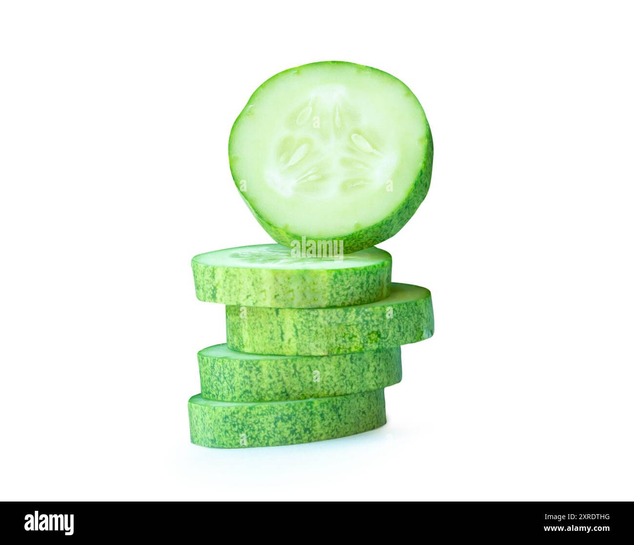 Green cucumber slices or pieces in stack are isolated on white ...