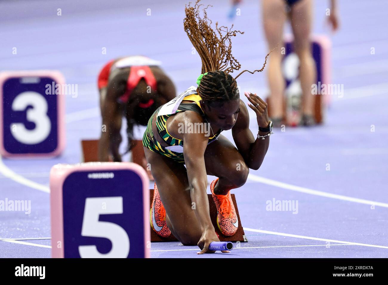 Alana Reid of Jamaica fixes her hair as she prepares to compete in the ...