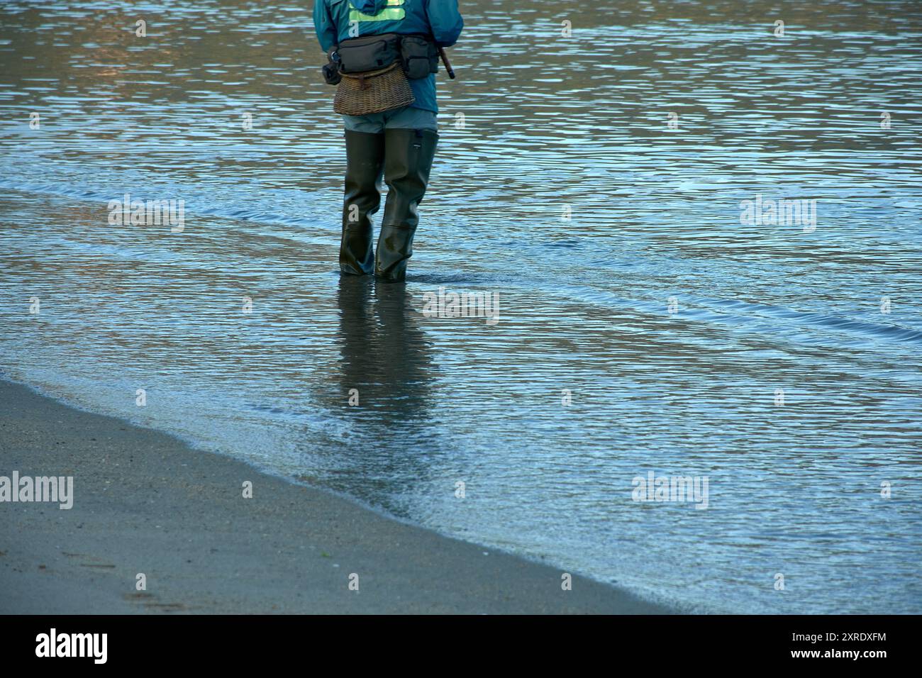 the traditional attire of a fisherman wading in the water, equipped ...