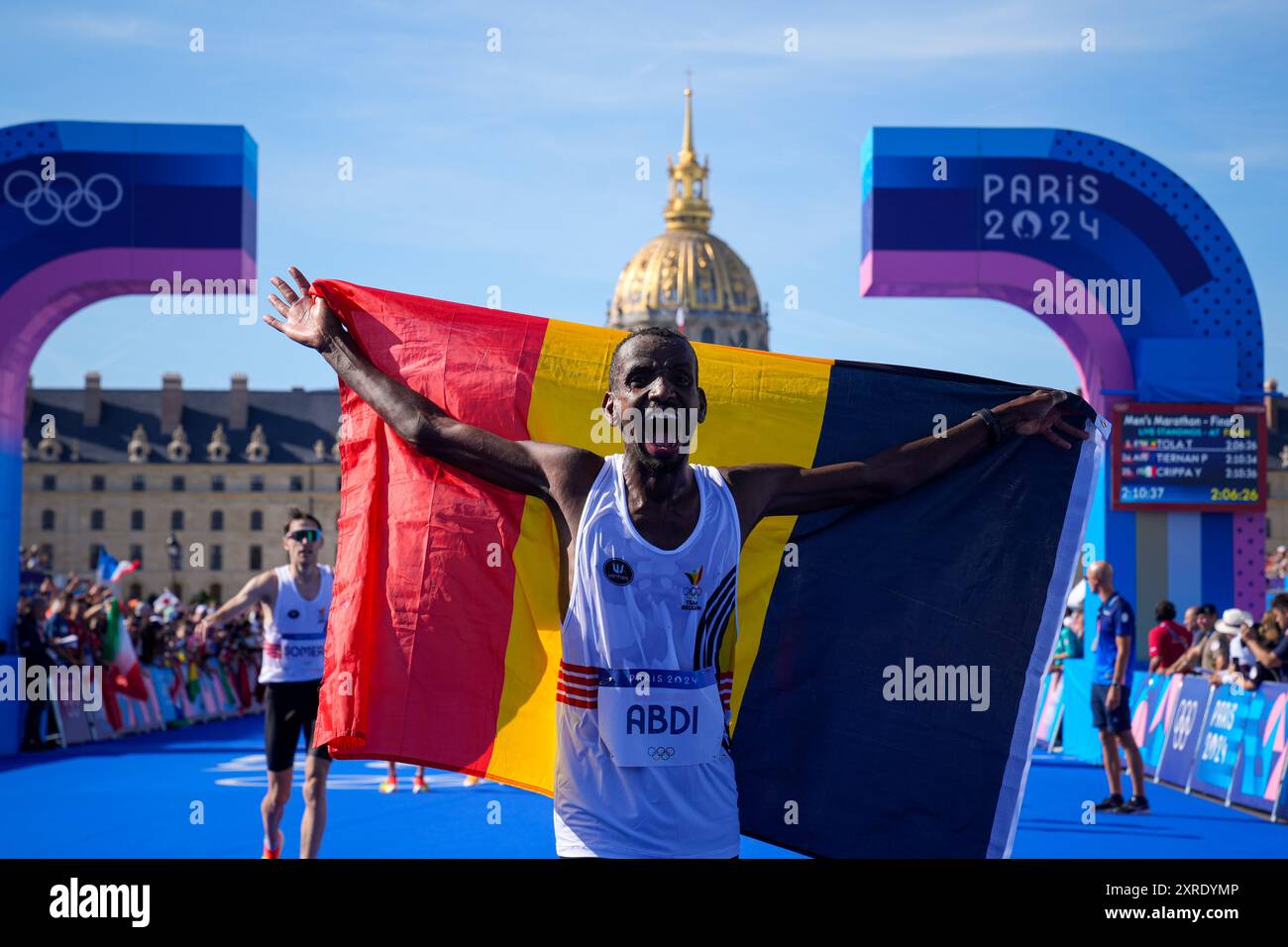 Belgium's Bashir Abdi celebrates after crossing the finish line to win ...