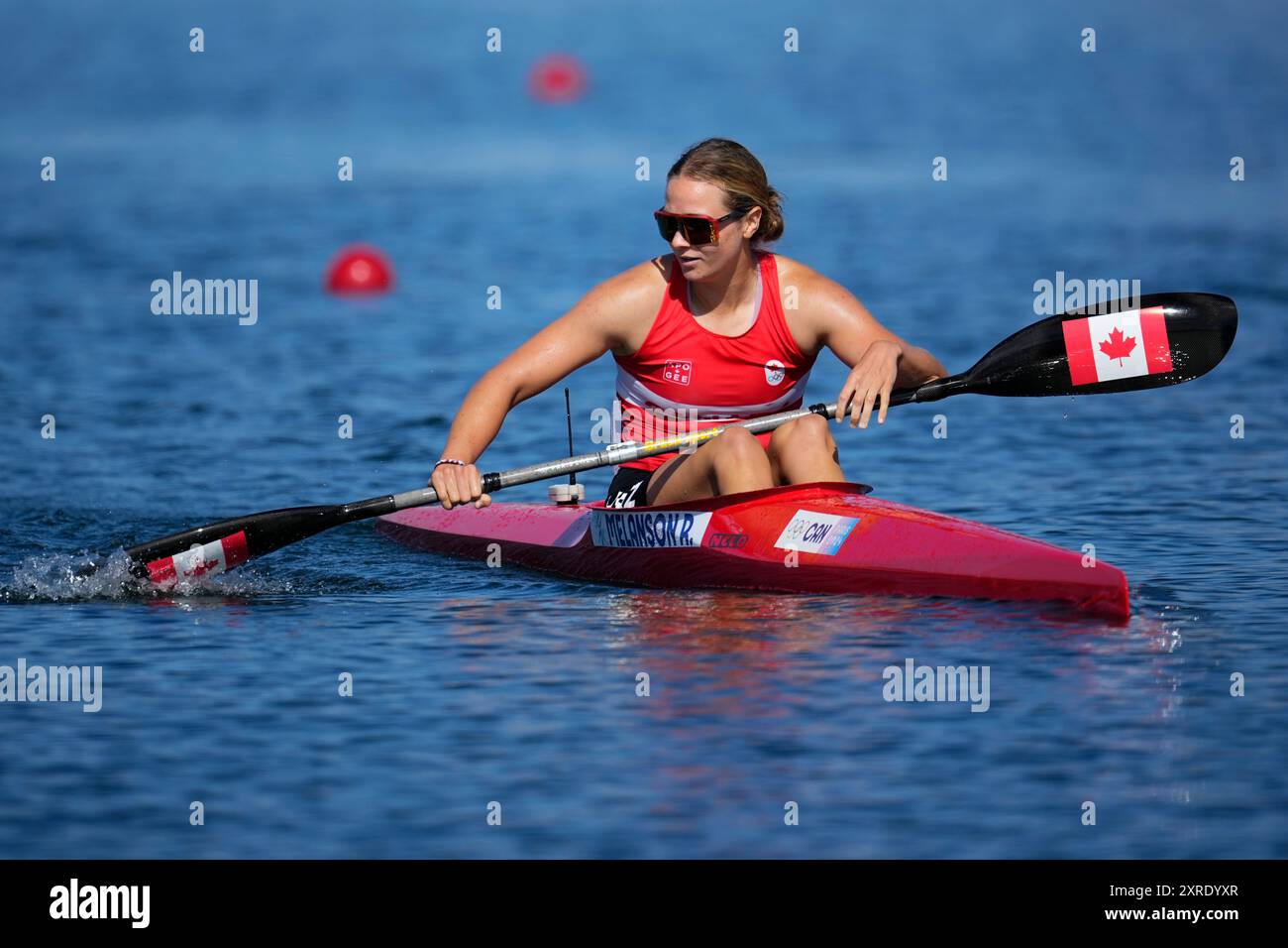Riley Melanson, of Canada, rests after competing in the women's kayak ...