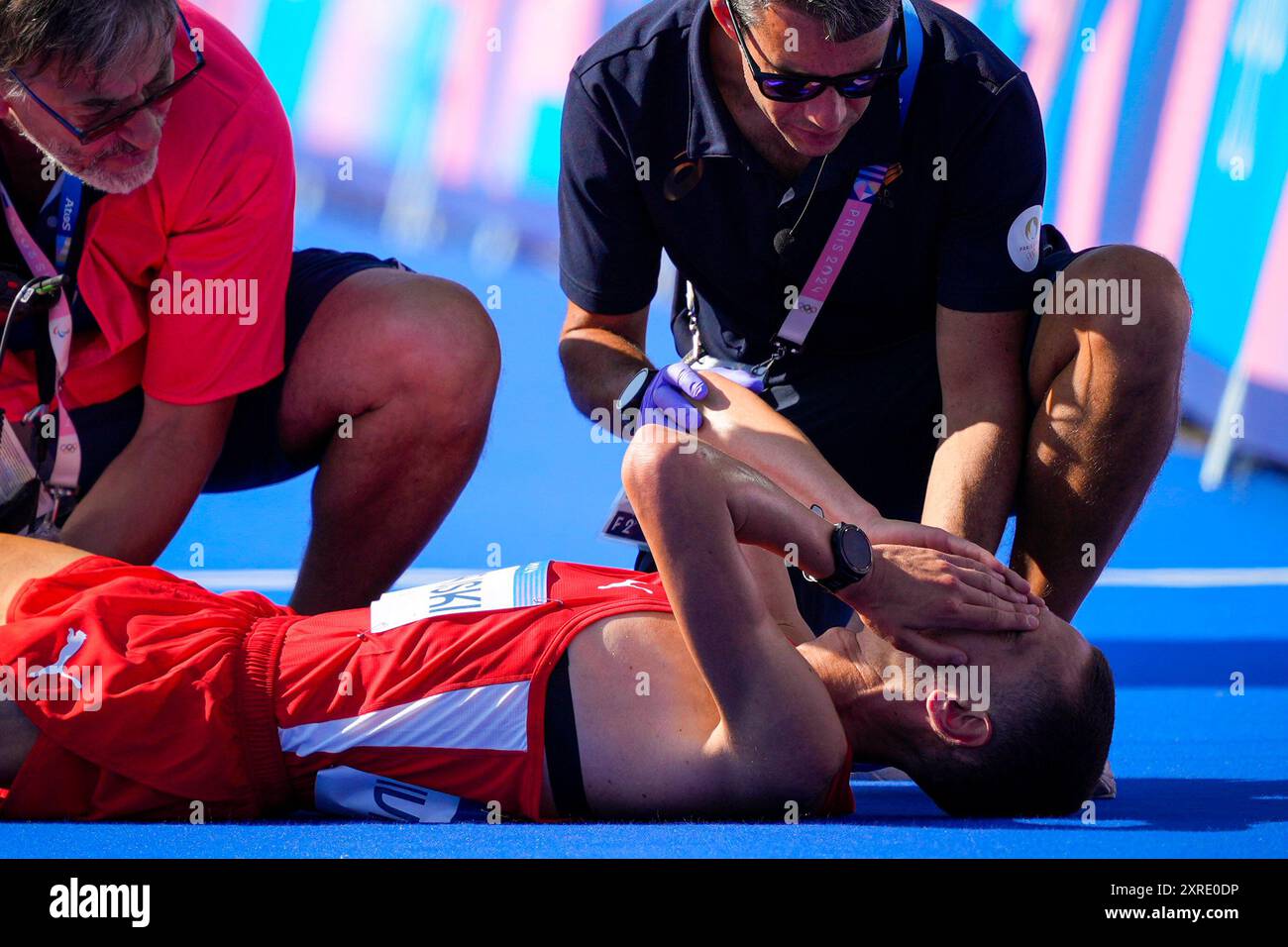North Macedonia's Dario Ivanovski grimaces in pain after crossing the ...