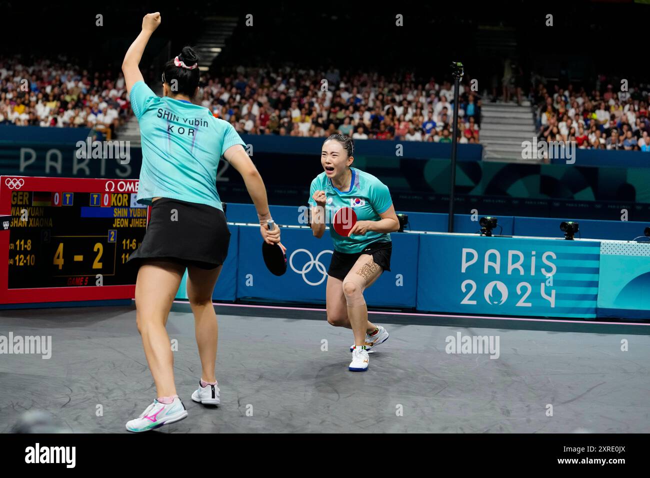 South Korea's Shin Yubin, left, and Jeon Jihee celebrate a winning ...