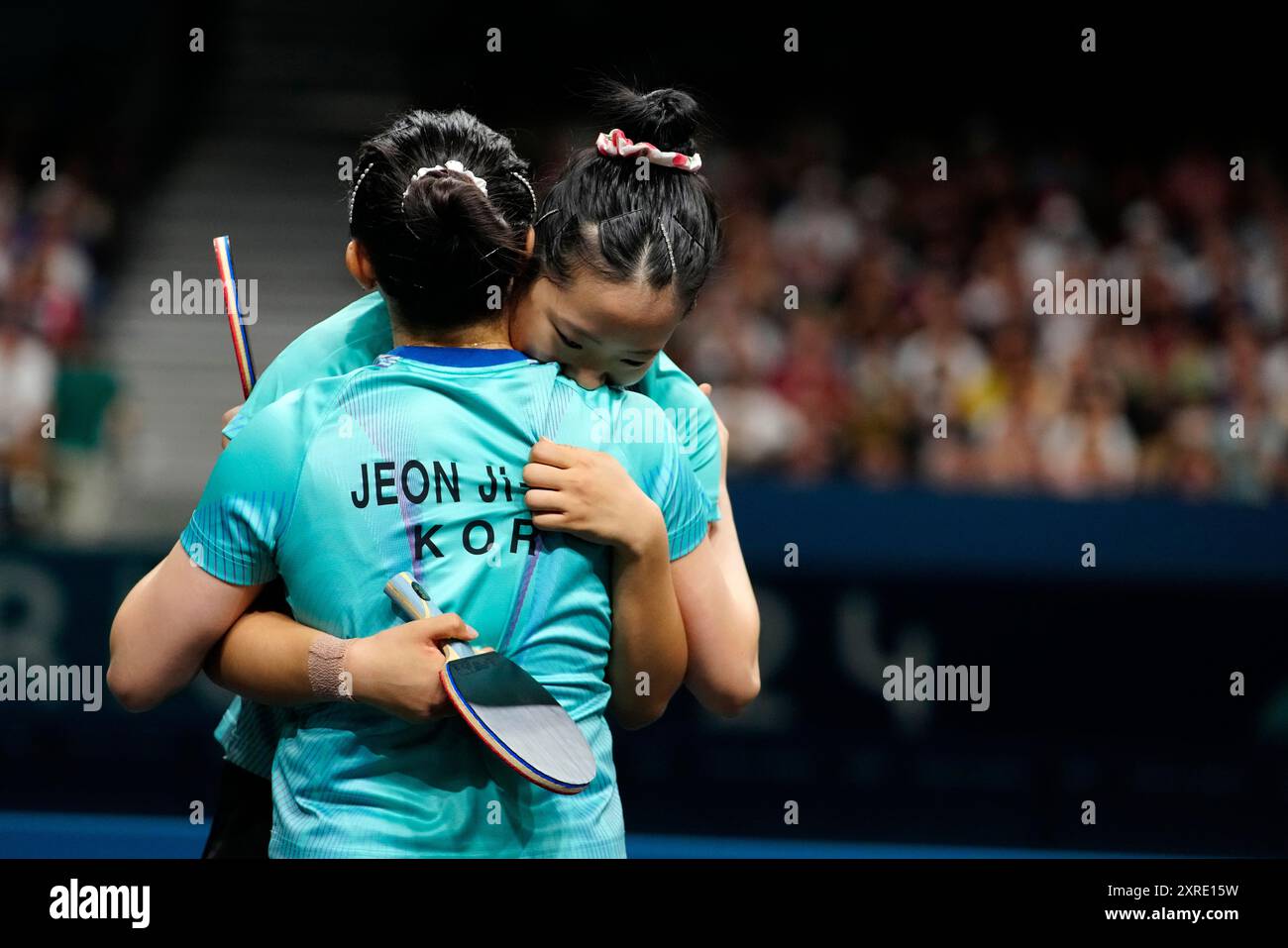 South Korea's Shin Yubin, background, hugs Jeon Jihee after defeating Germany's Yuan Wan and ...
