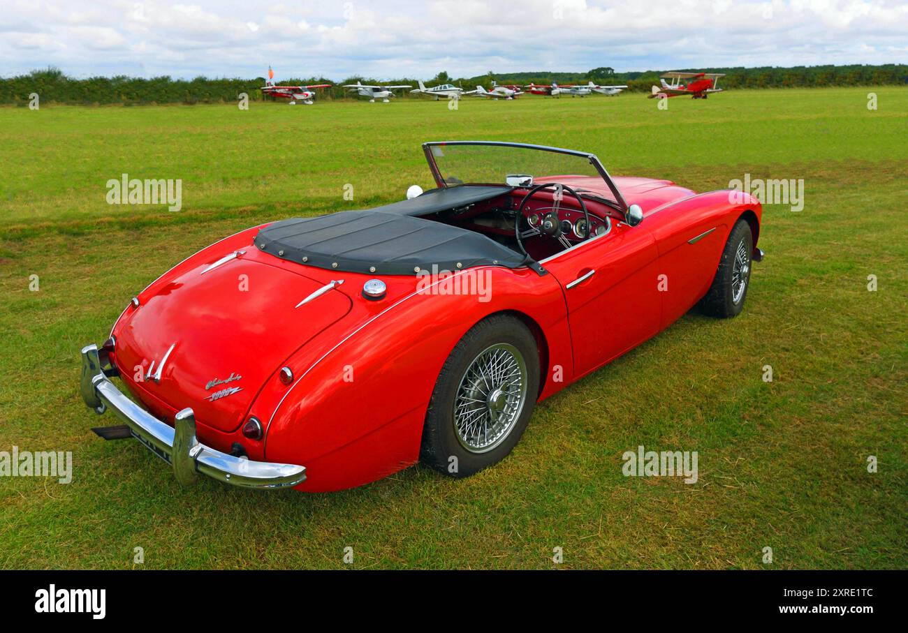 Classic Red Austin Healey 3000 motor car parked on airstrip with ...