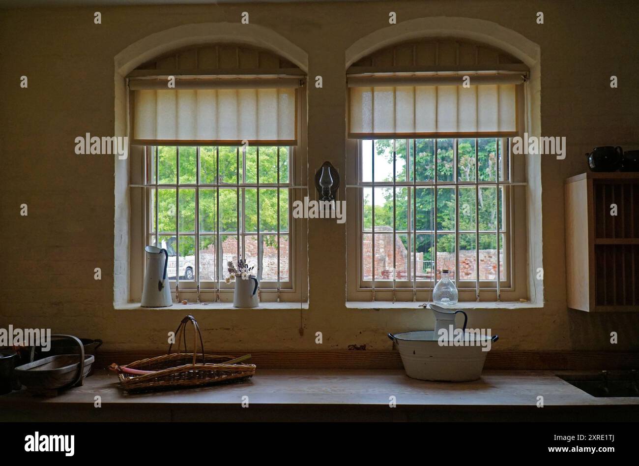 Vintage Kitchen Bared Windows with worktop and jug Stock Photo - Alamy
