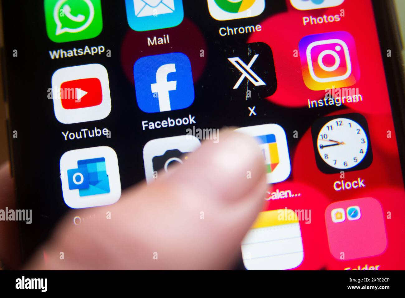 A close-up of a smartphone screen displaying popular social media apps ...