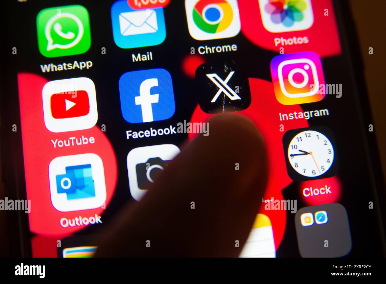 A close-up of a smartphone screen displaying popular social media apps ...